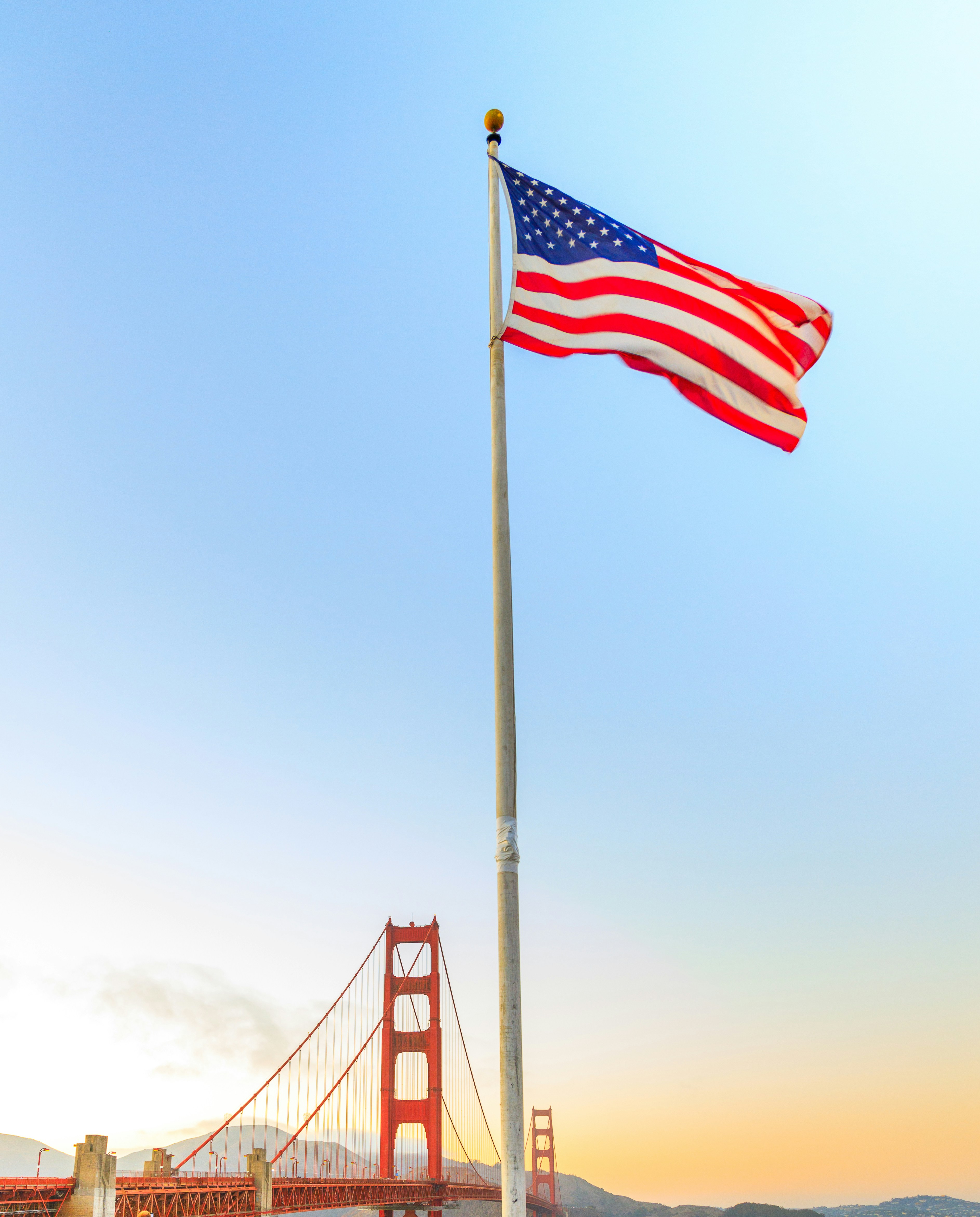 Waves of Freedom: A Flag's Embrace at Dusk
