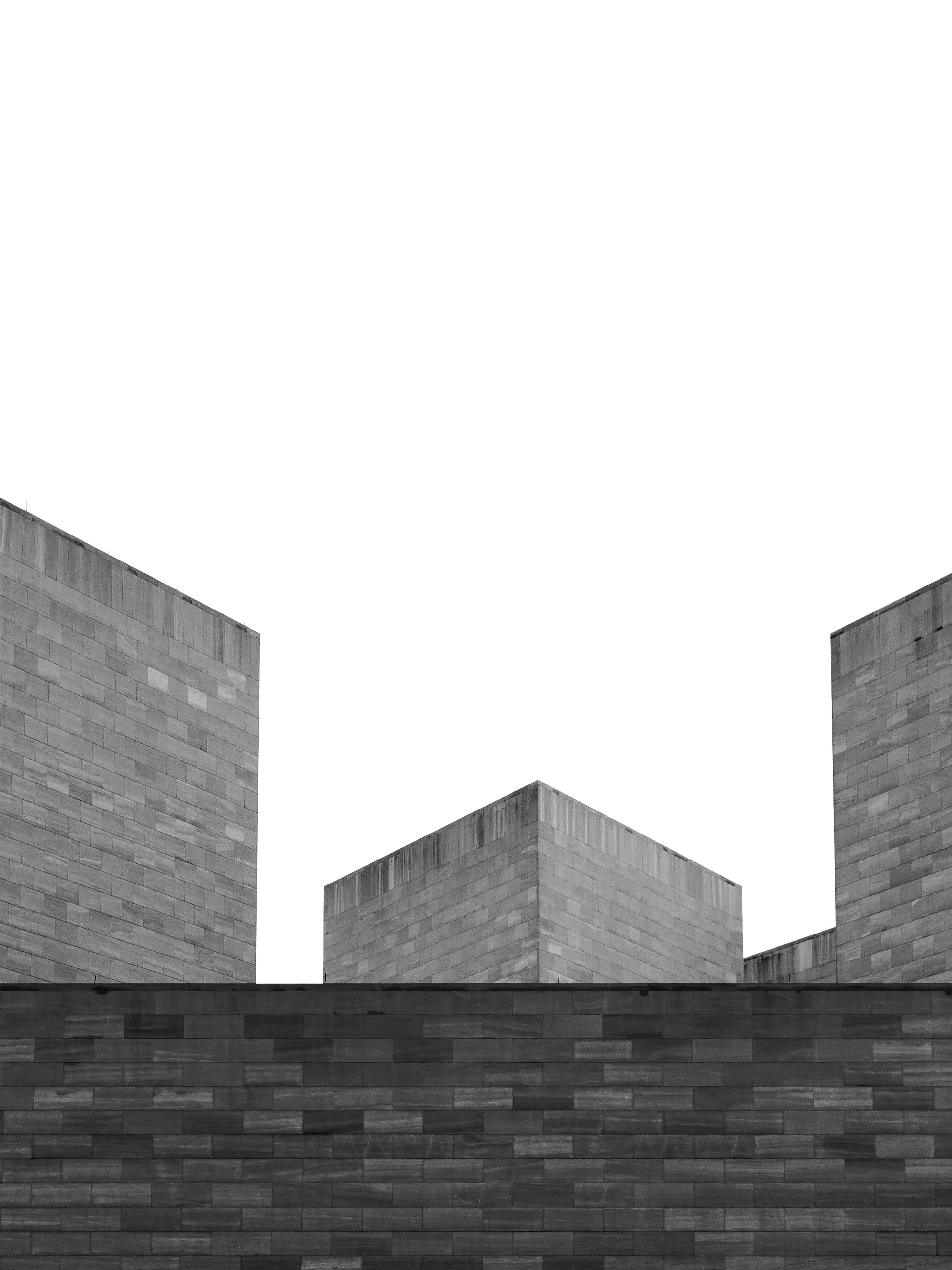 Modern architecture | Geometric concrete buildings against a white sky