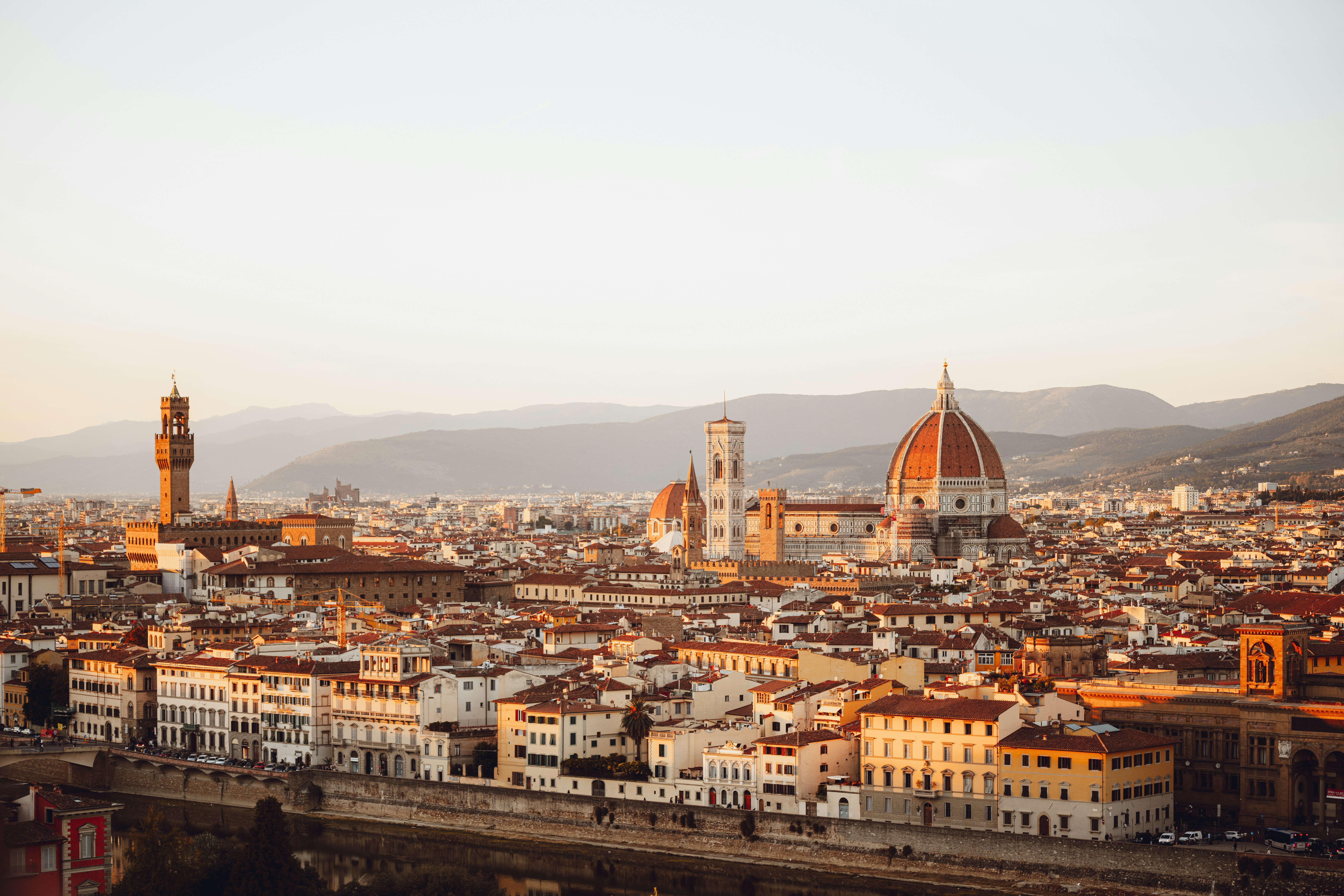 Florence cityscape with duomo and arno river at sunset