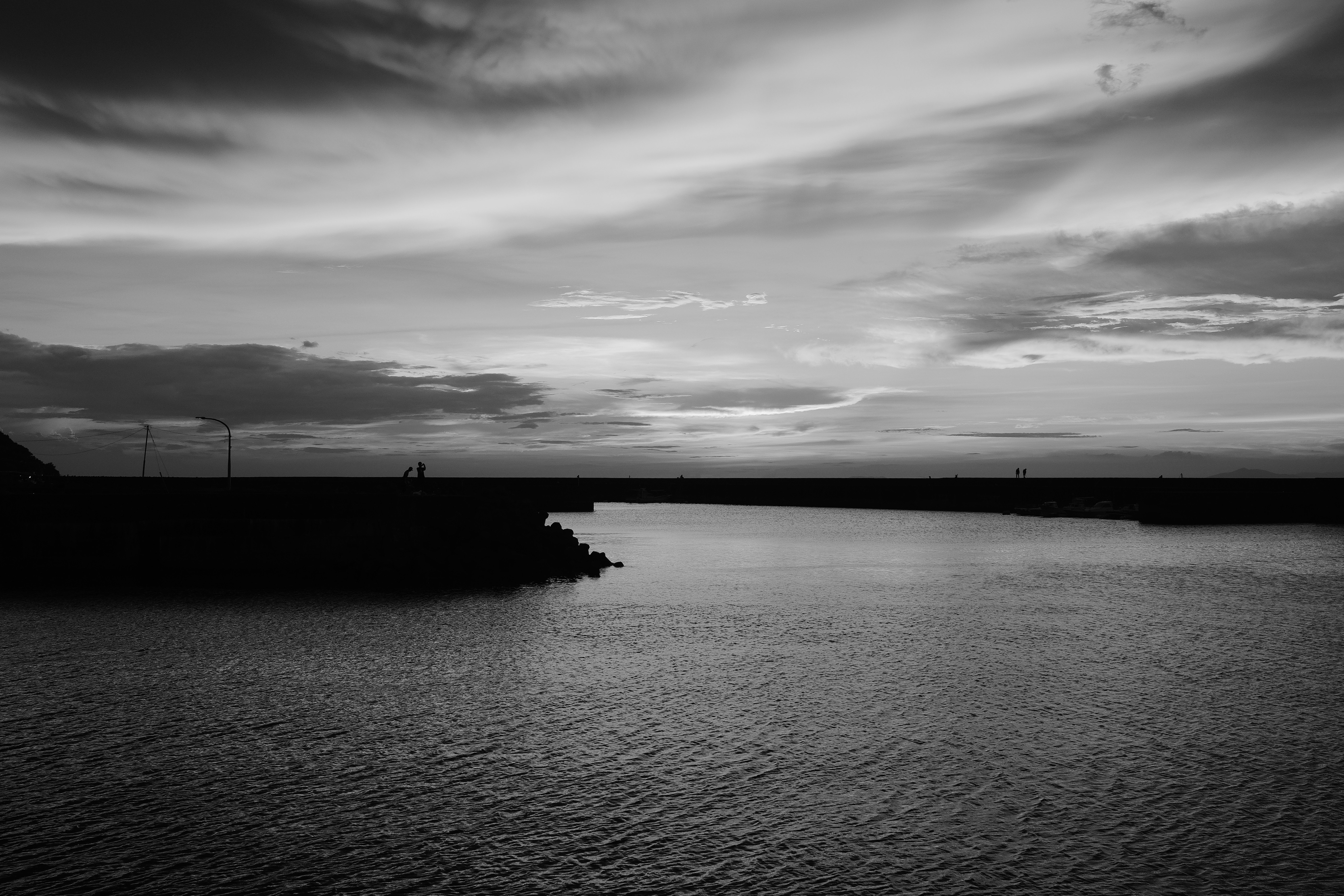 Black and white sunset over a calm body of water.