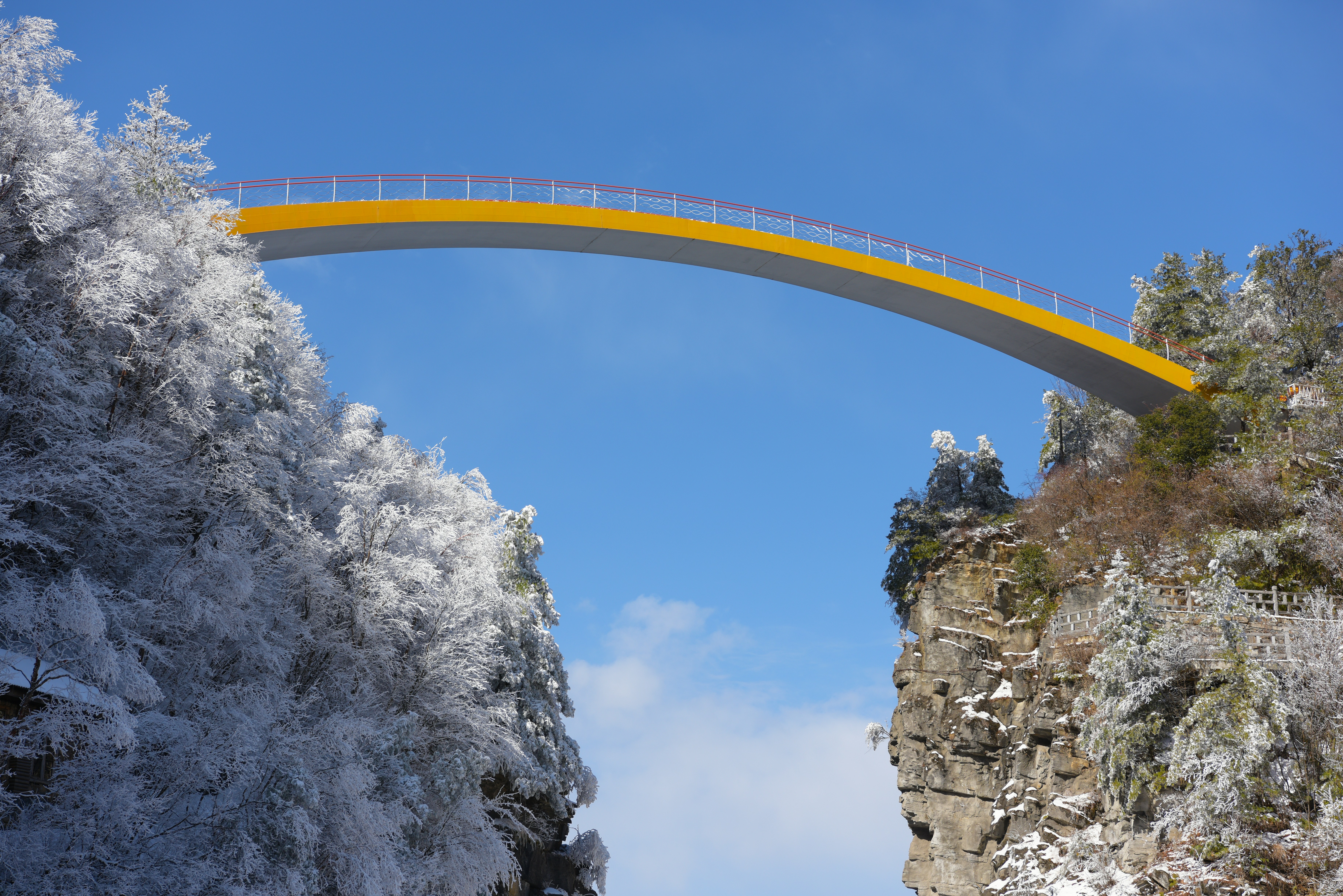 A Bold Arc Amidst Frosted Peaks