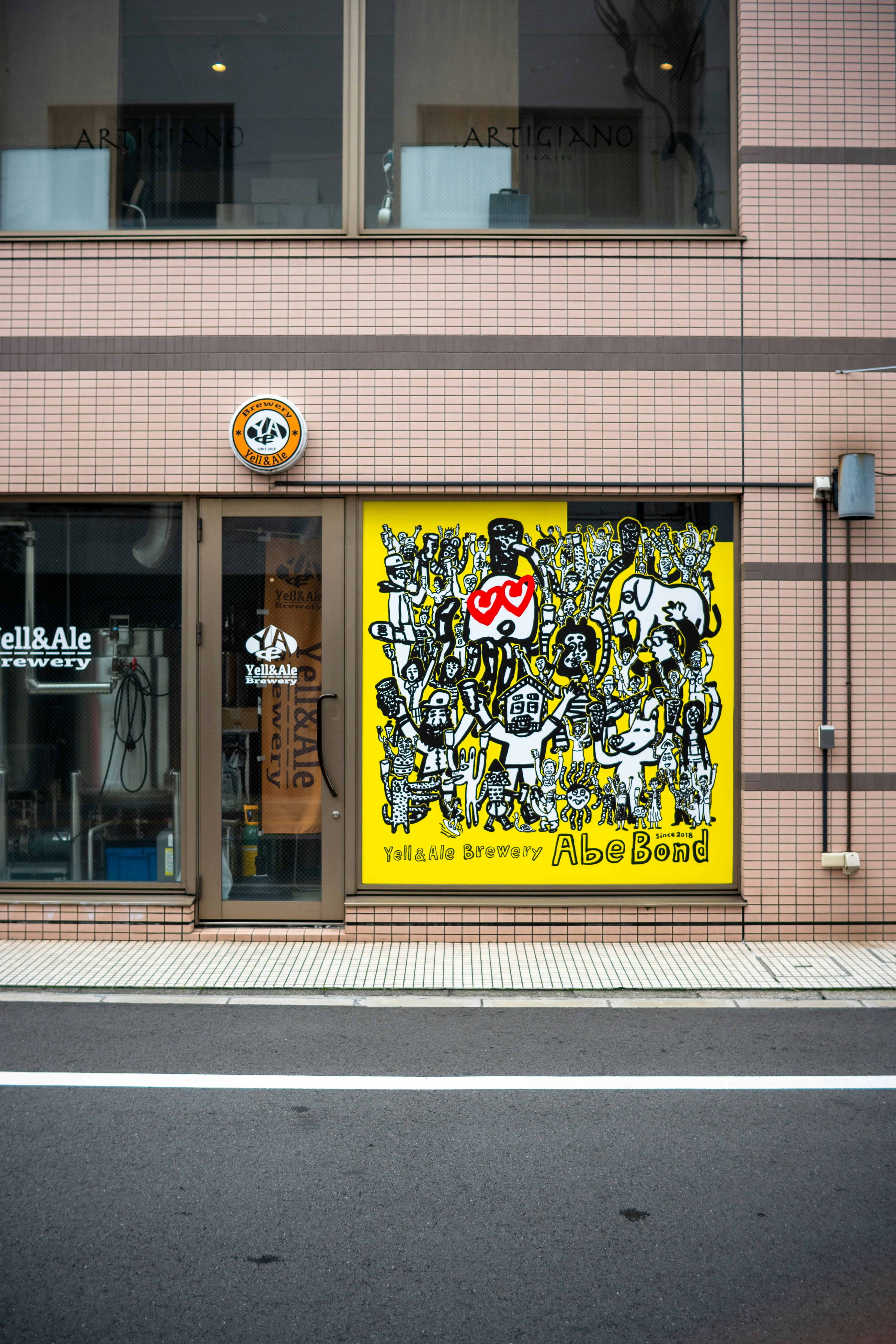 Colorful mural featuring whimsical characters and designs on a brewery's exterior wall, showcasing local artistry and creativity.