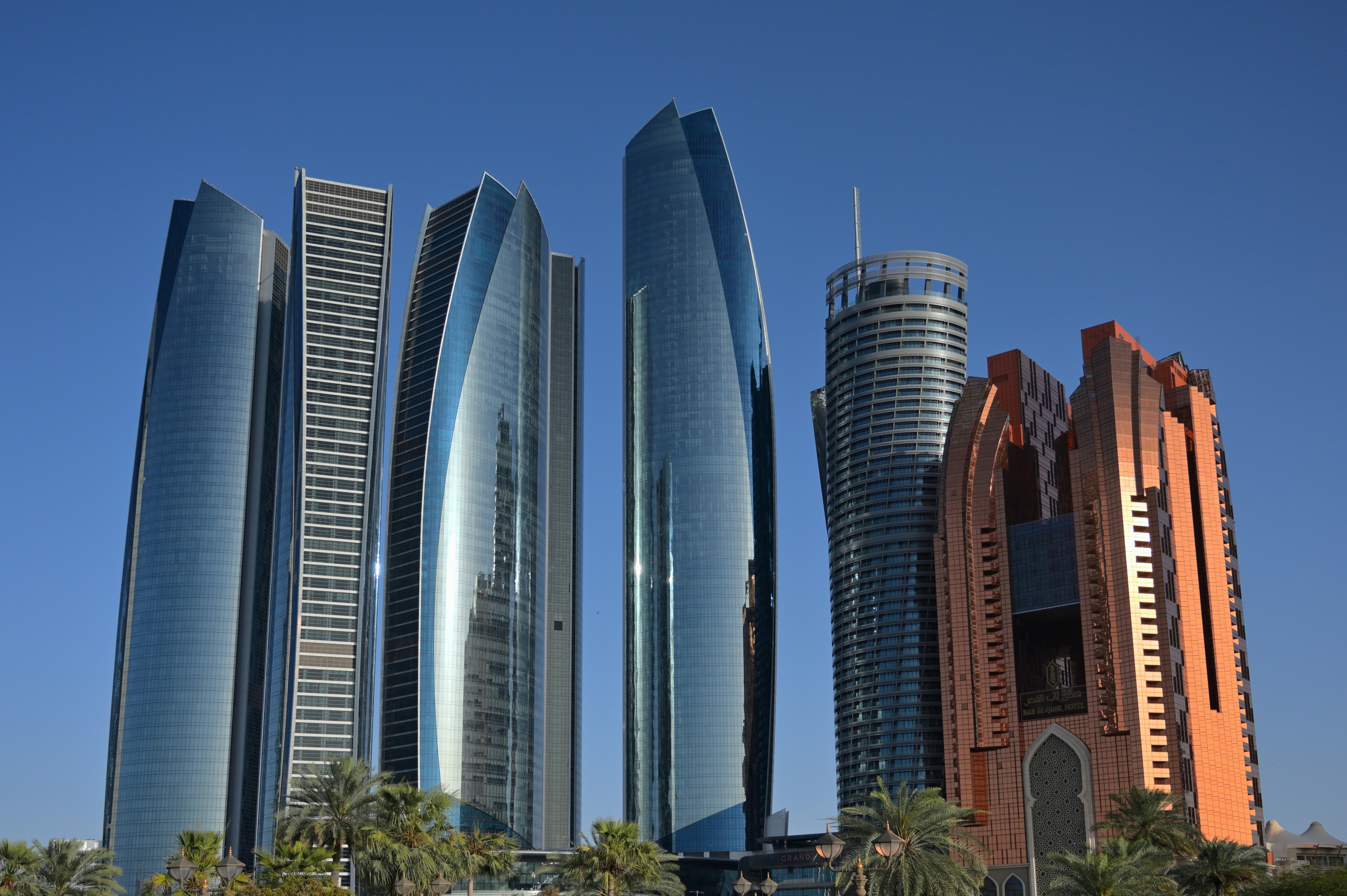 Modern skyscrapers against a clear blue sky.