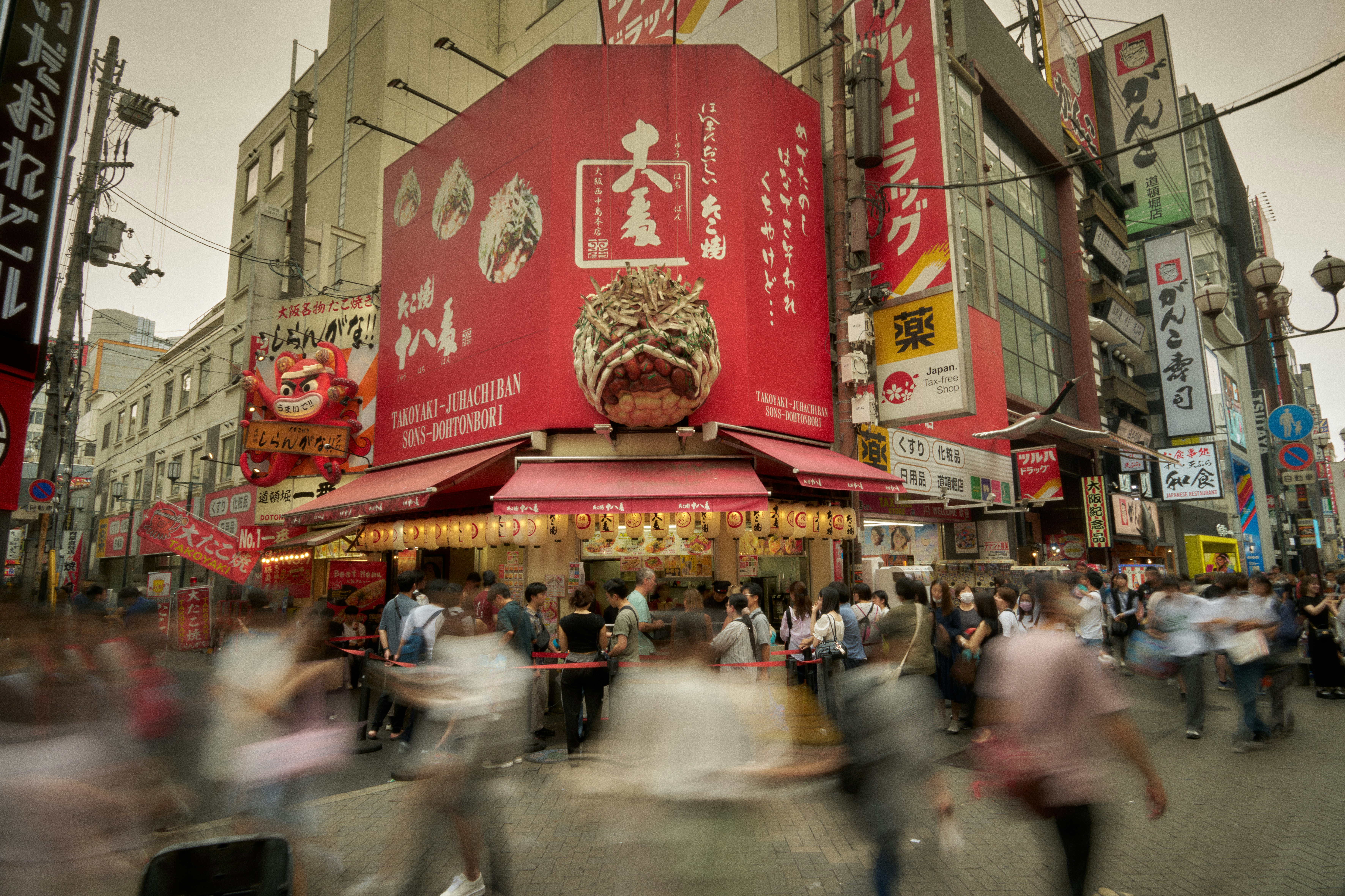 Crimson Giant Sign Over Osaka's Dotonbori: A Crowd-Kissed Street Food Scene