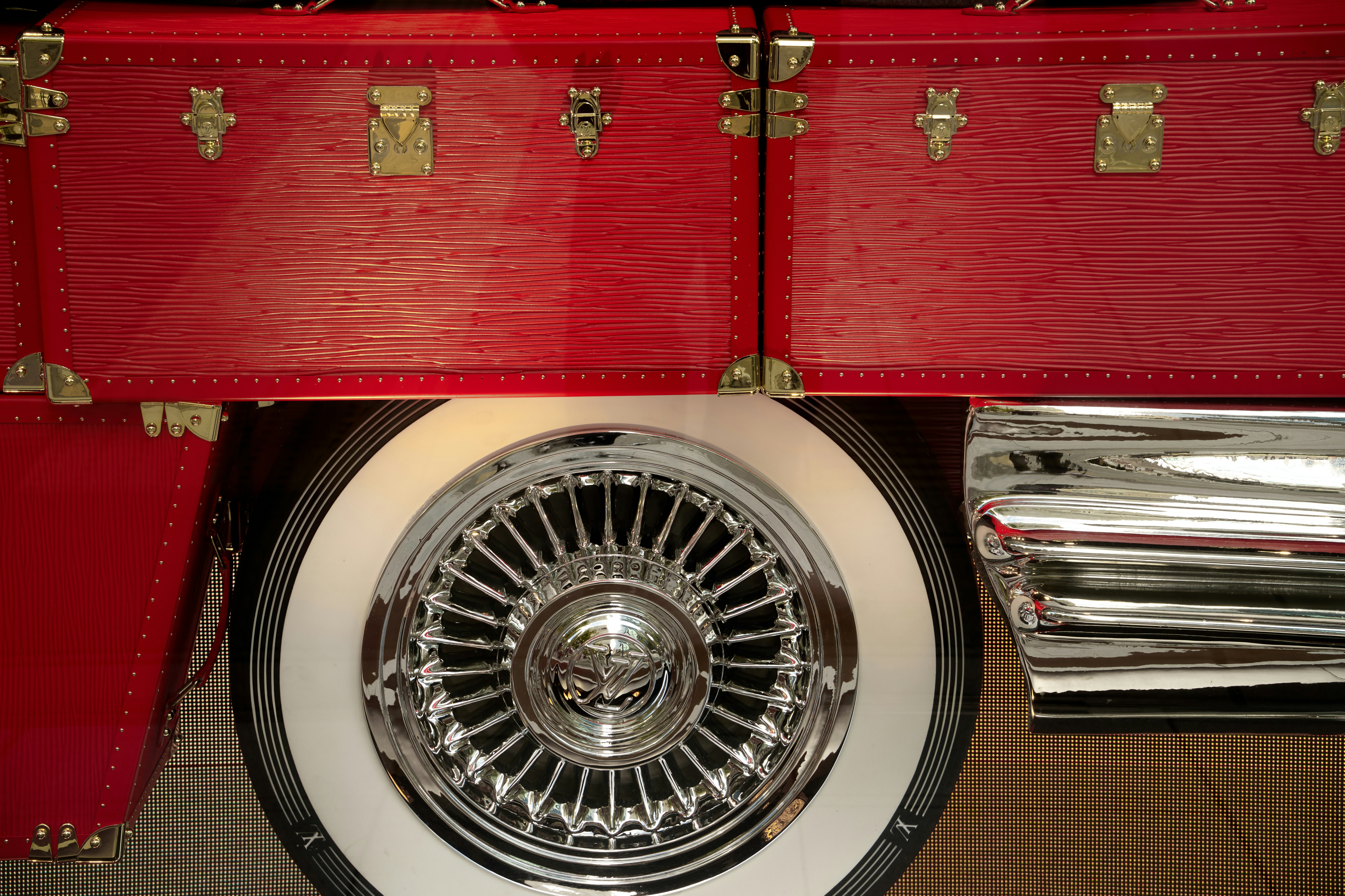 Red trunks and vintage car wheel