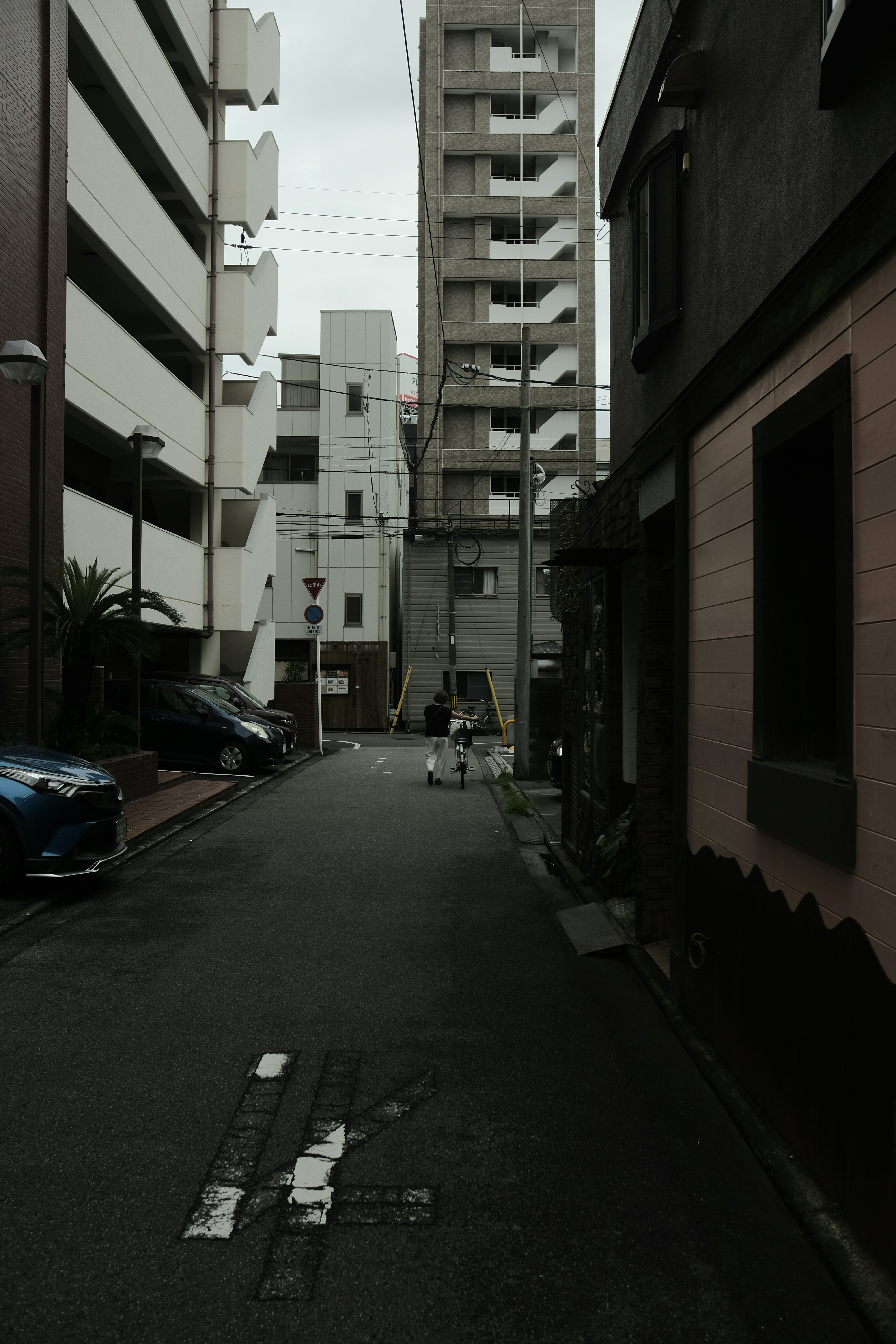 Narrow street between apartment buildings on a cloudy day