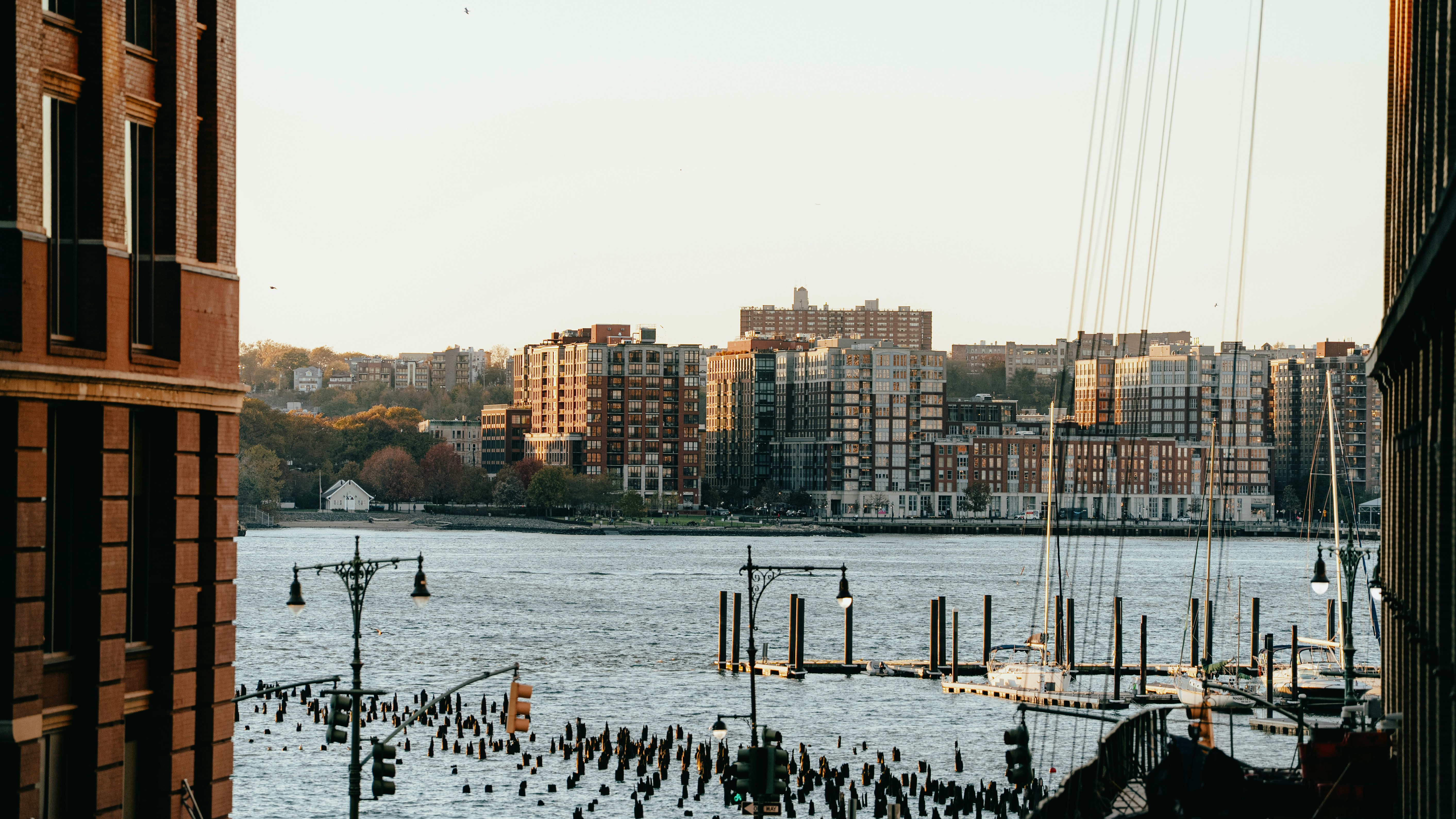 City skyline with river and boats at sunset
