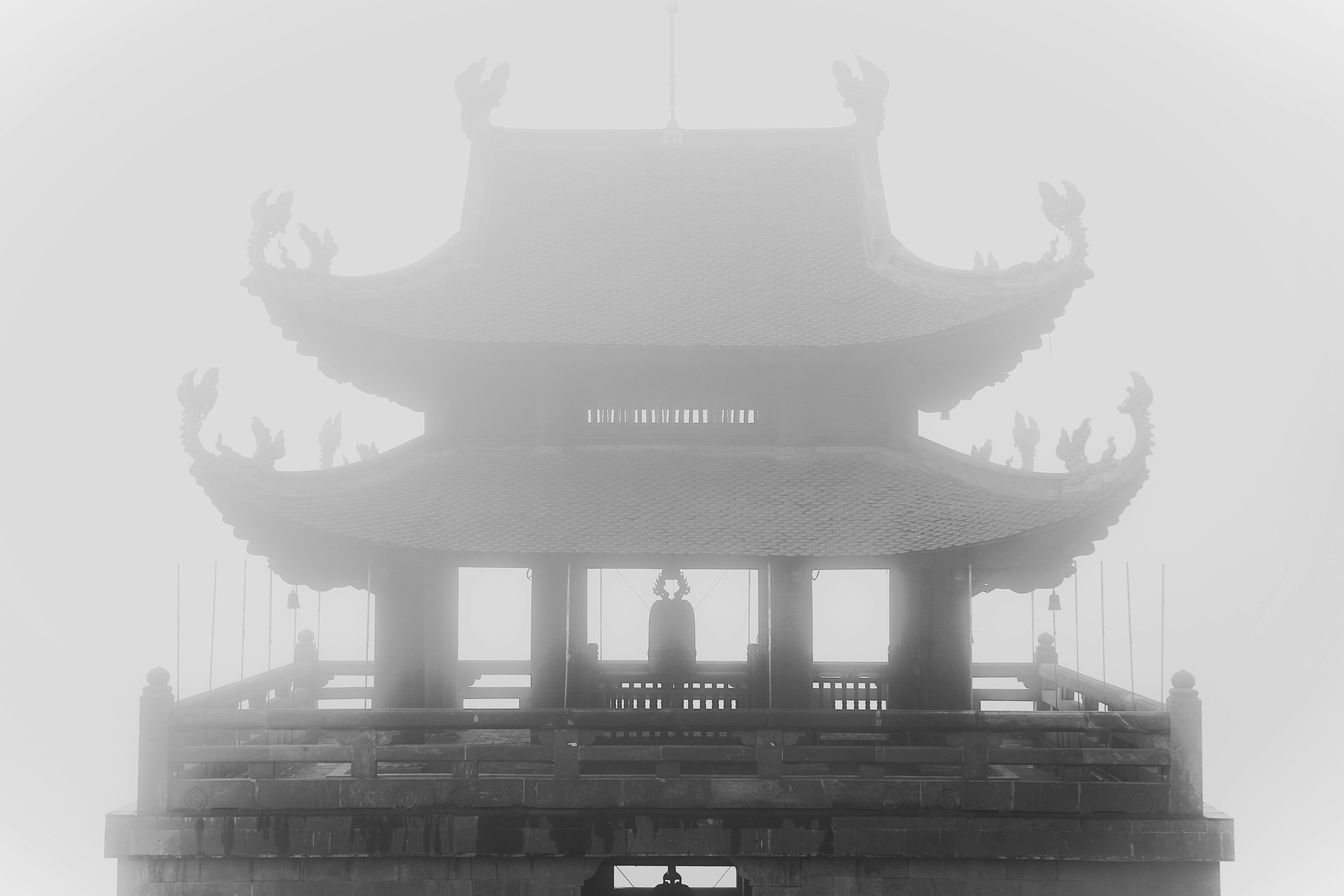 A pagoda structure shrouded in thick fog