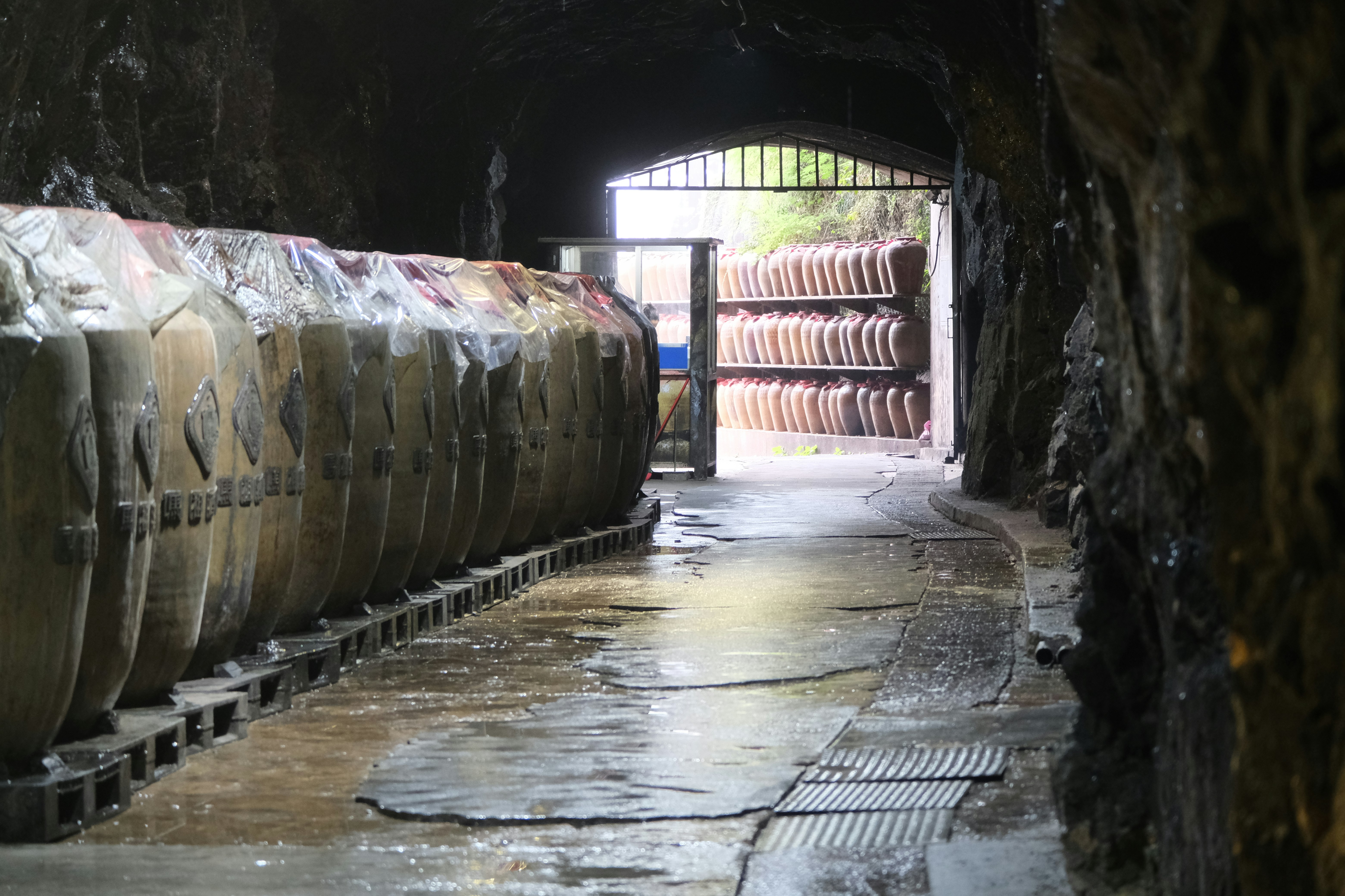 Sunlit Exit Beyond a Barrel-Lined Tunnel
