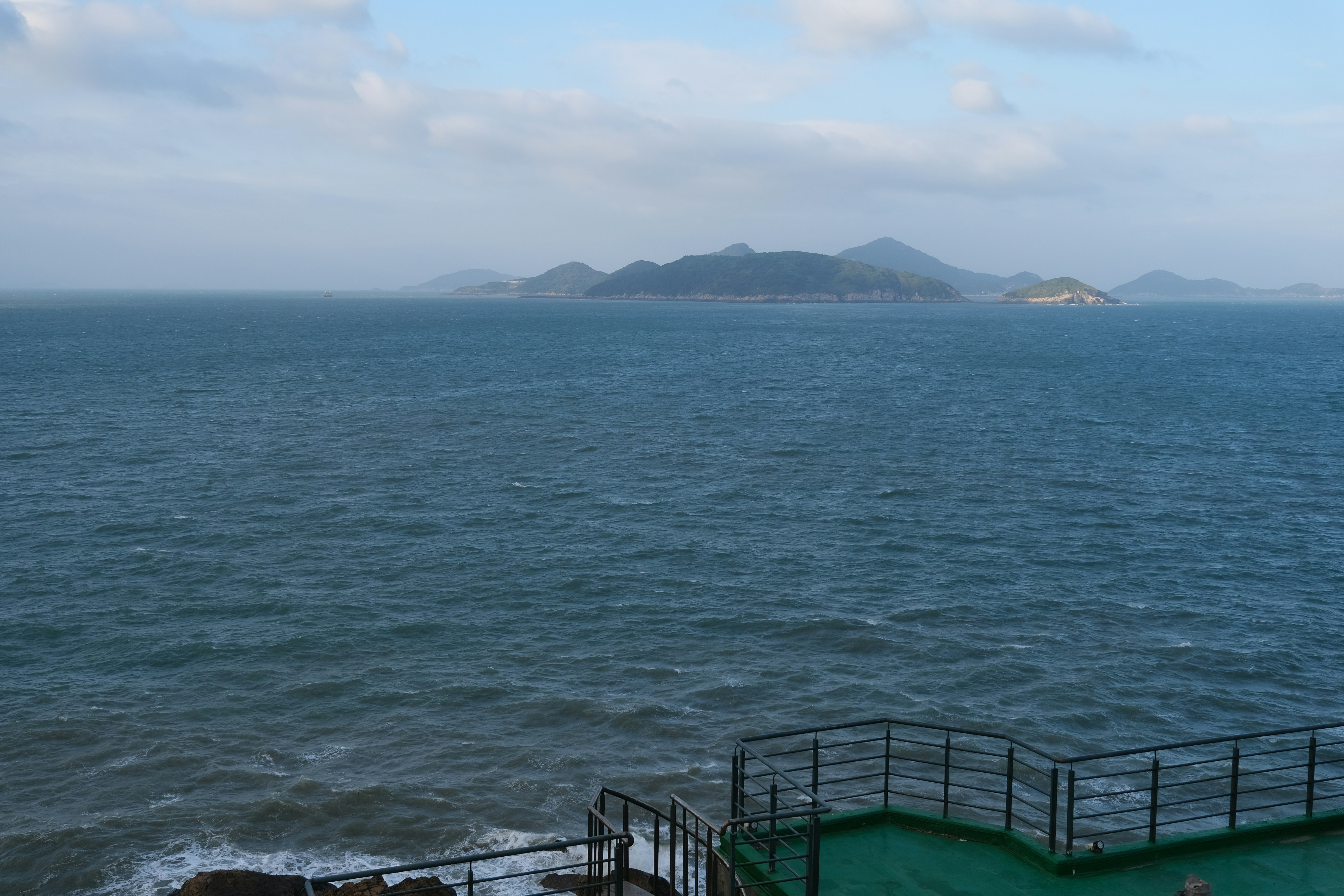 Islands on the horizon over a choppy blue ocean