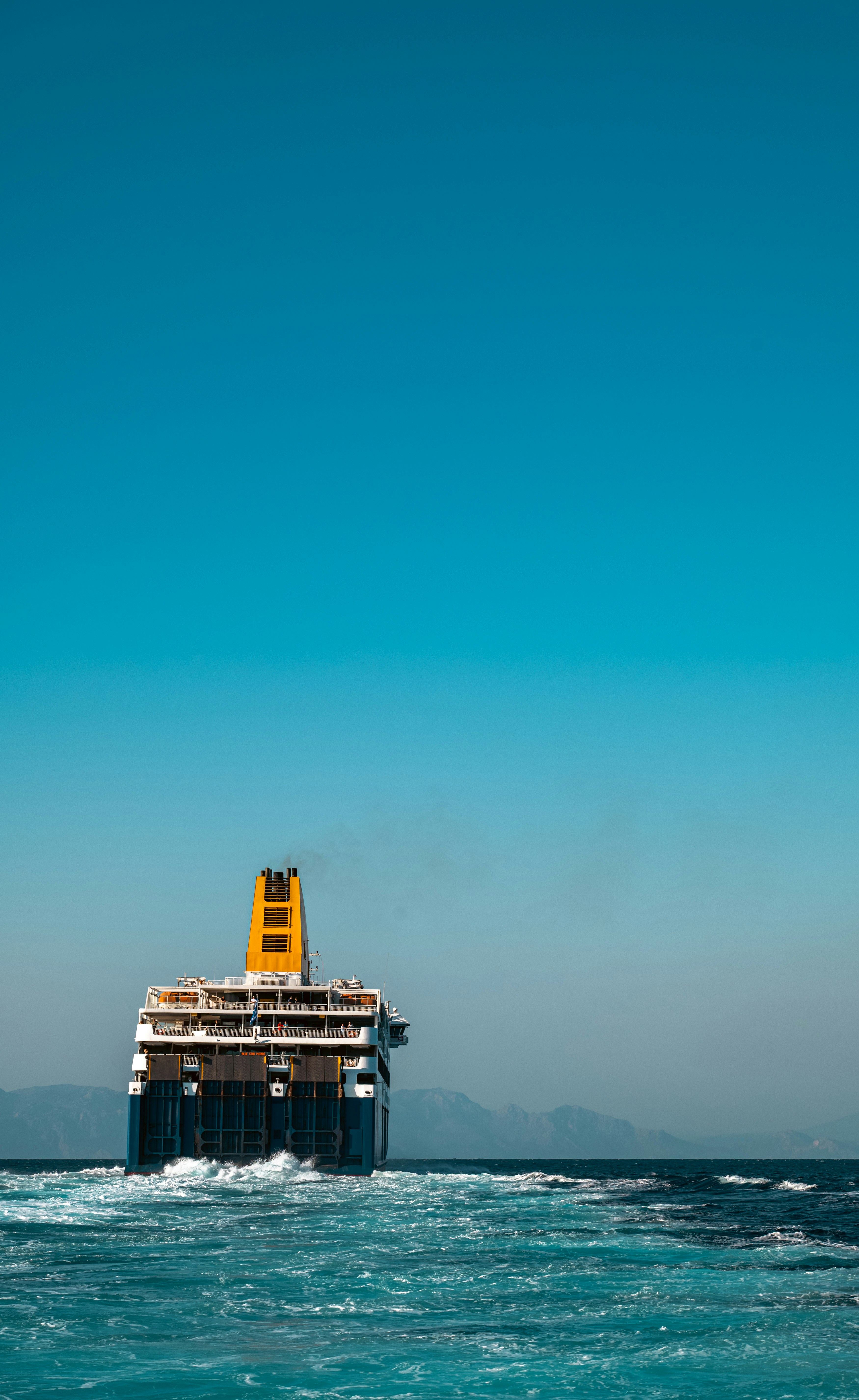 Yellow-Funnel Freighter Pierces the Turquoise Calm
