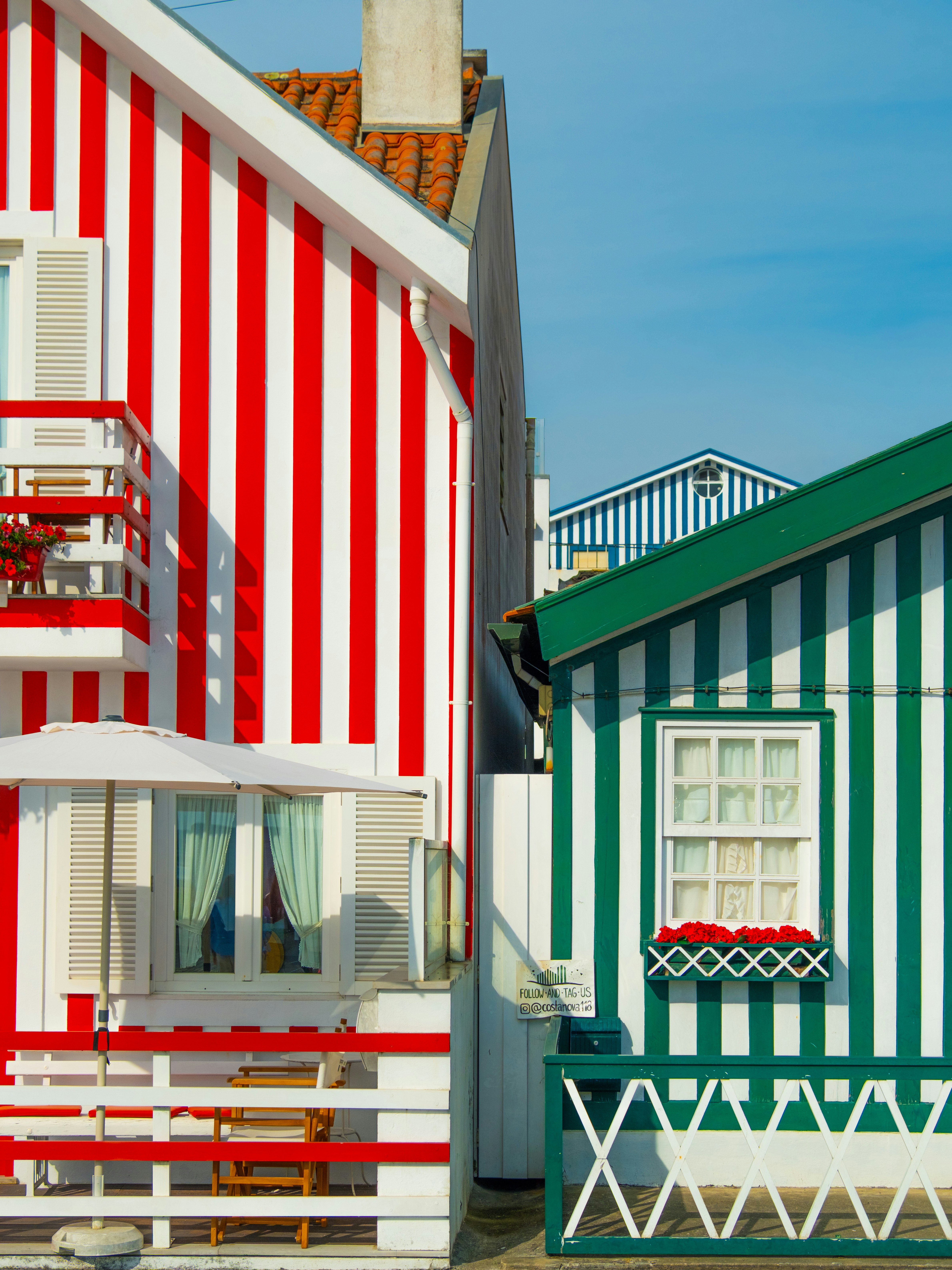 Aveiro, Portugal | Striped houses in red, white, and green under blue sky