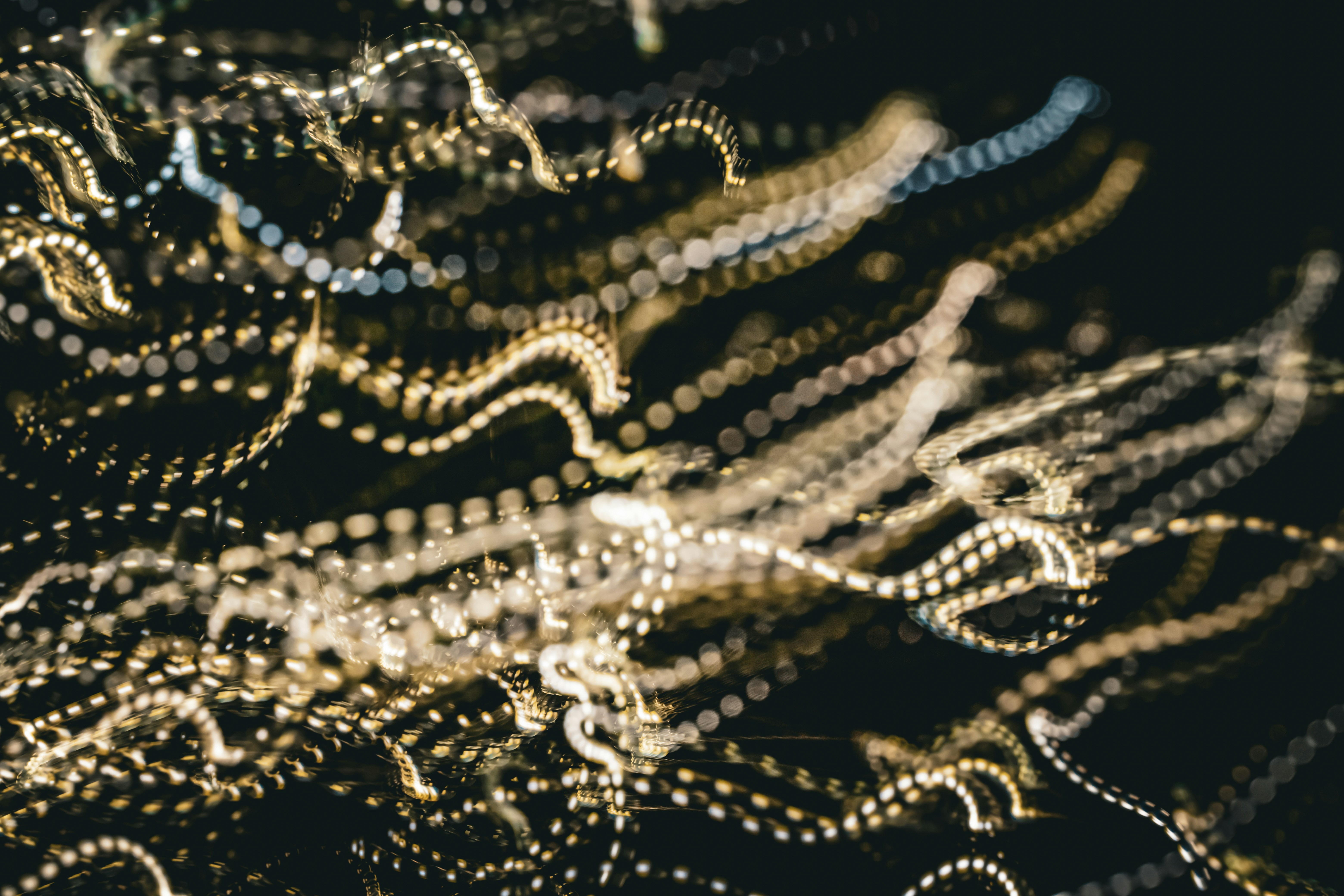 Abstract streaks of golden light on black background