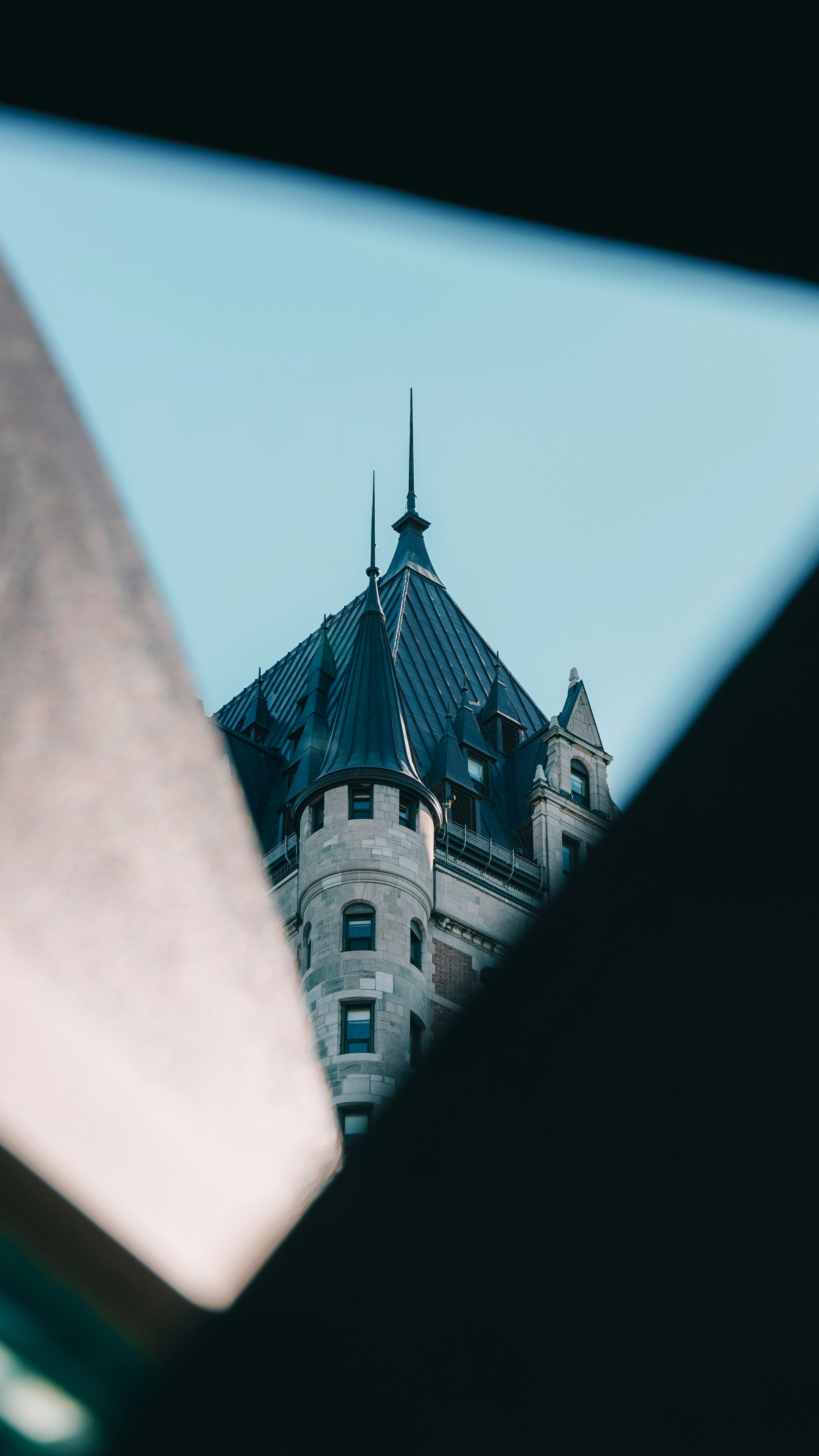 Stone building with conical towers against blue sky