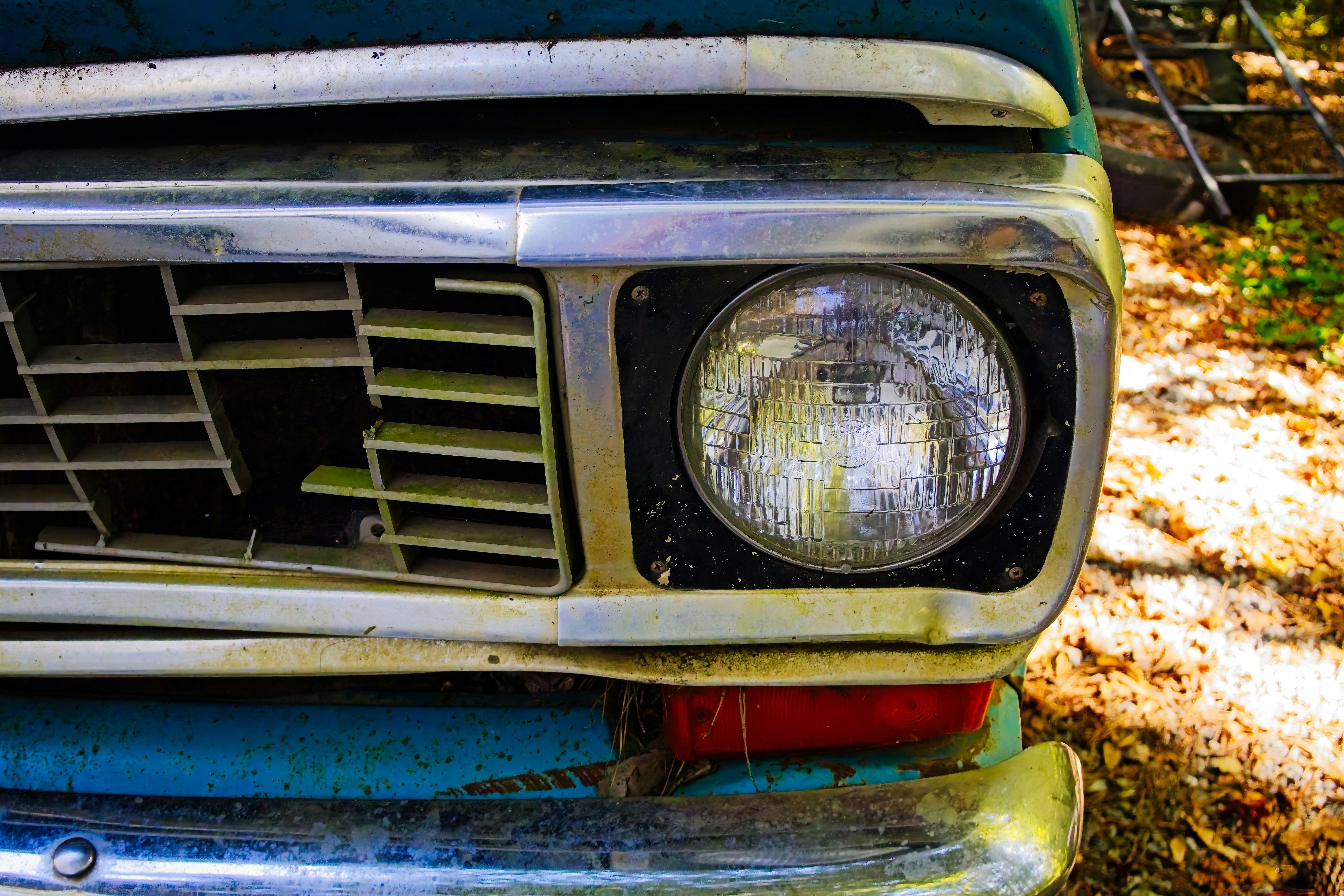 Close up of an old truck's headlight and grille