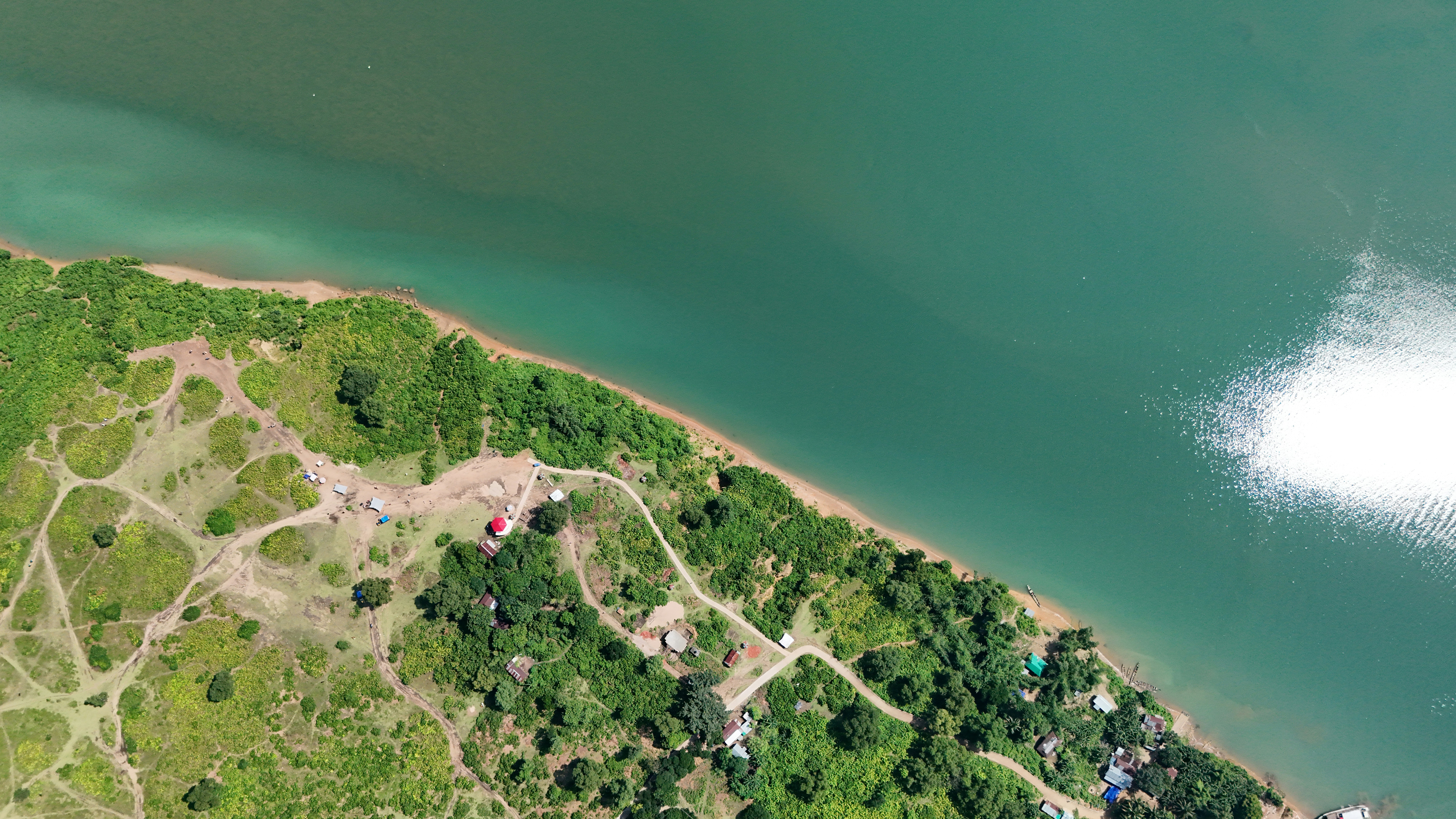 Travel View of Bangaldesh. | Aerial view of a green coastline meeting turquoise water.