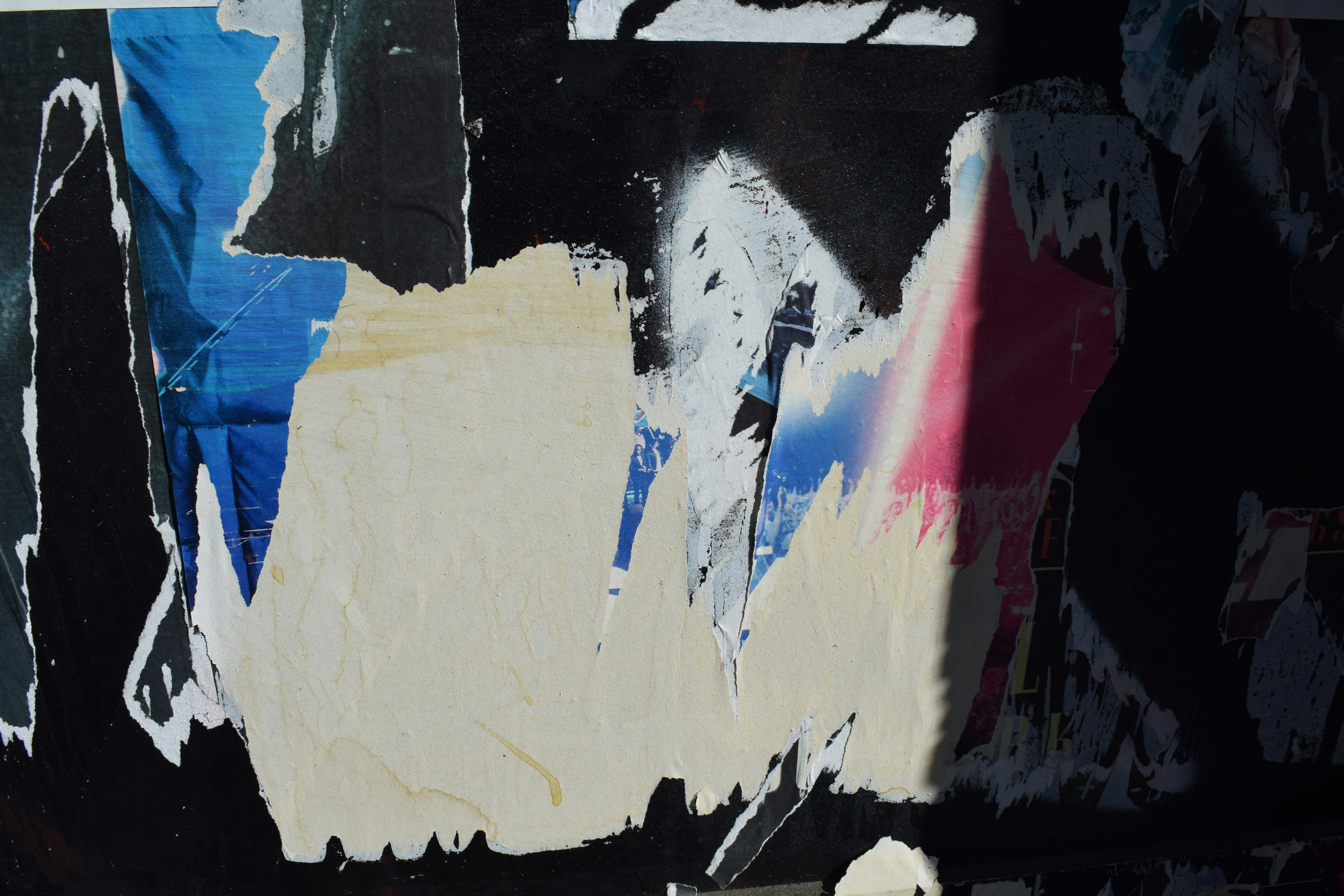 Torn paper posters on a black background