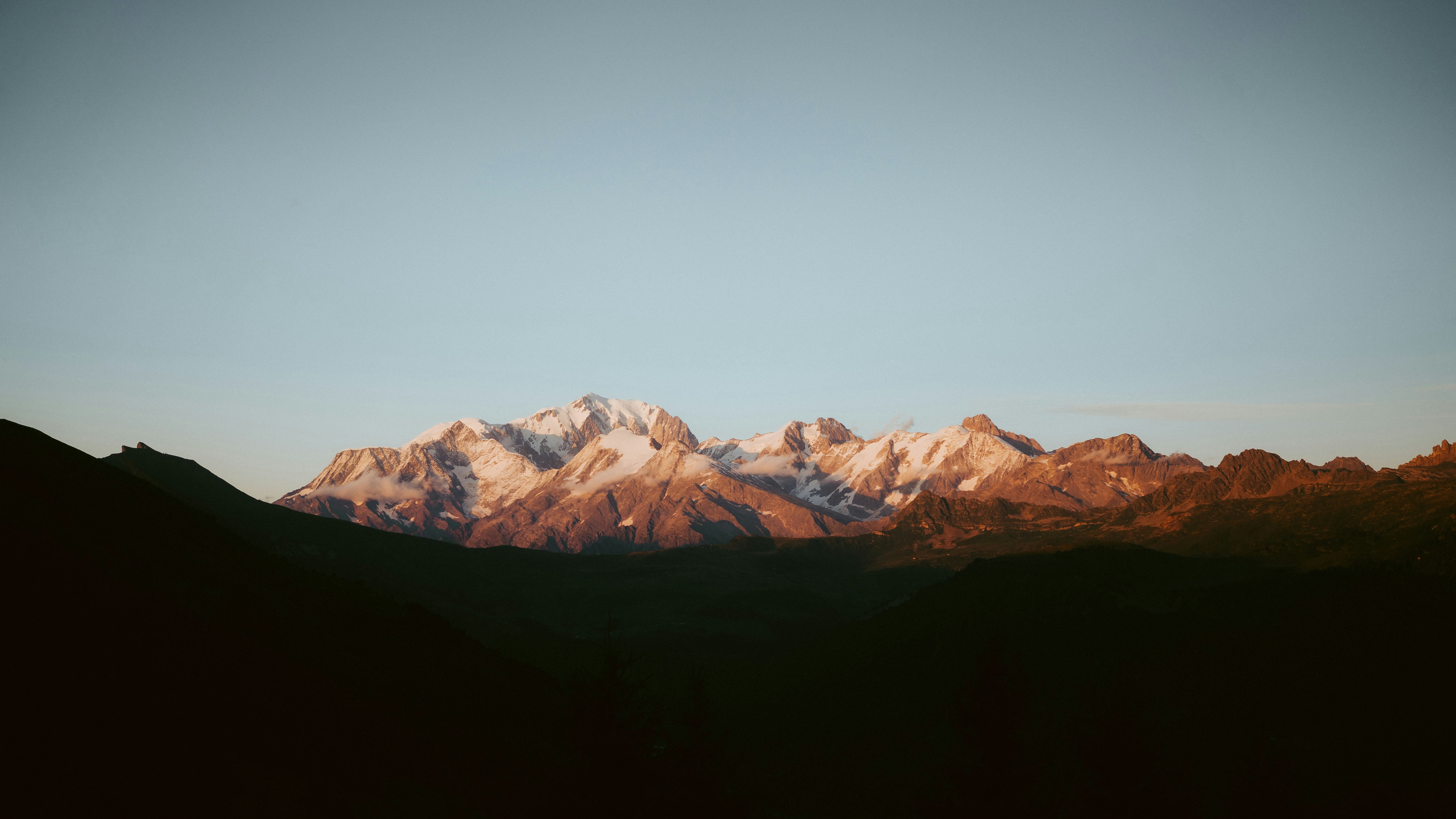 The Mont Blanc ridge in all its glory | Snow-capped mountains illuminated by golden hour sunlight.