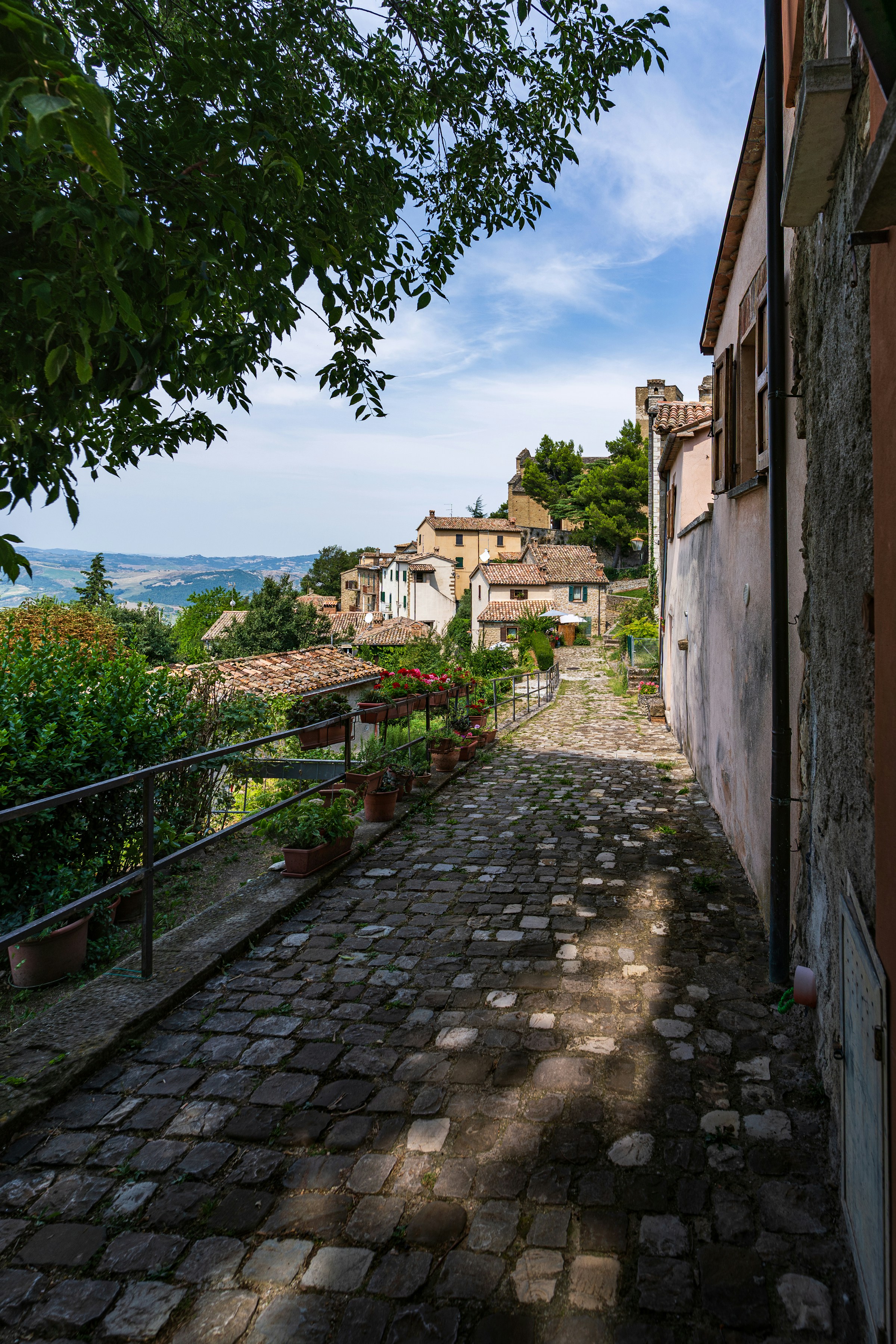 Cobblestone path leads to a charming italian village.
