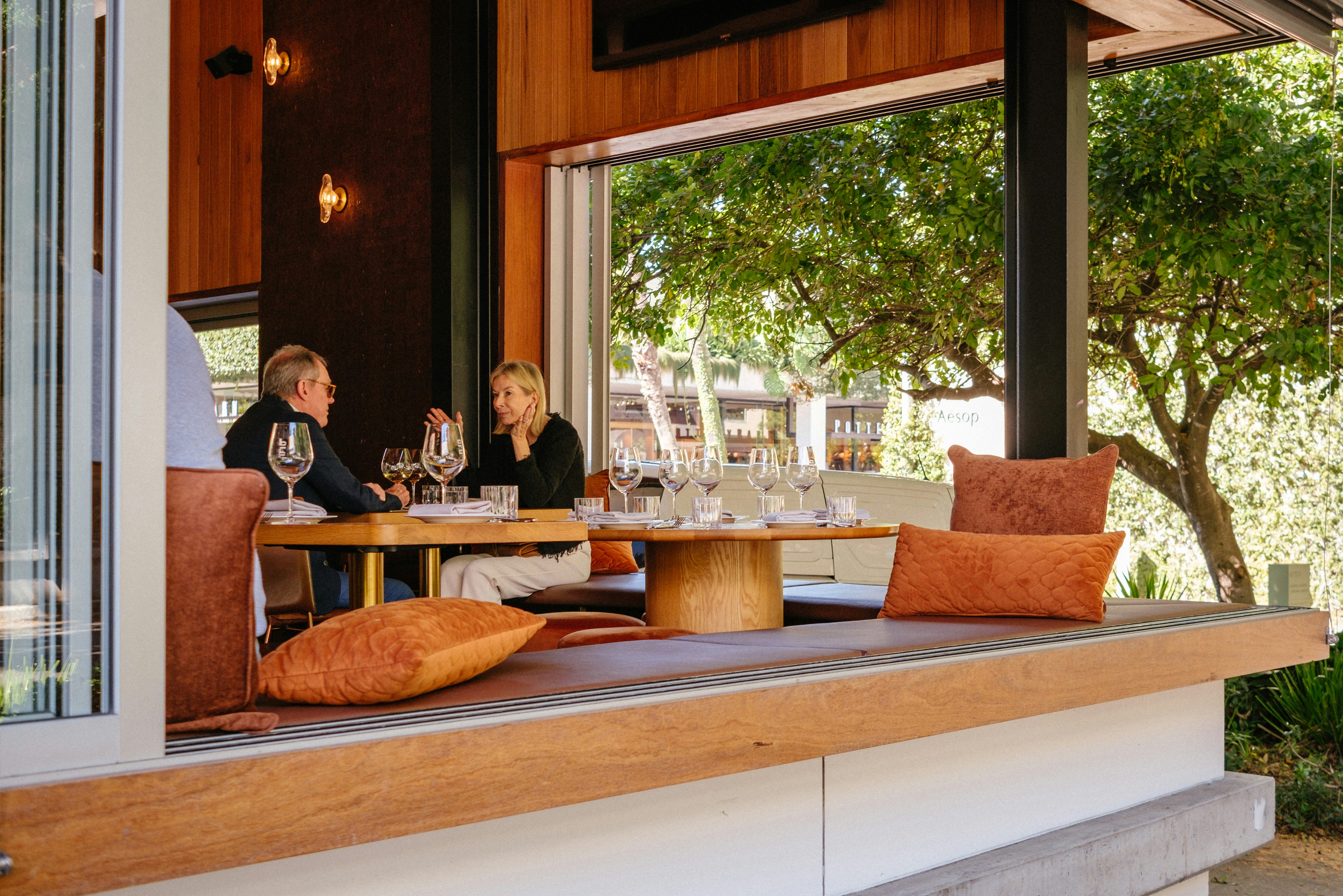 Two people enjoying wine tasting at a table