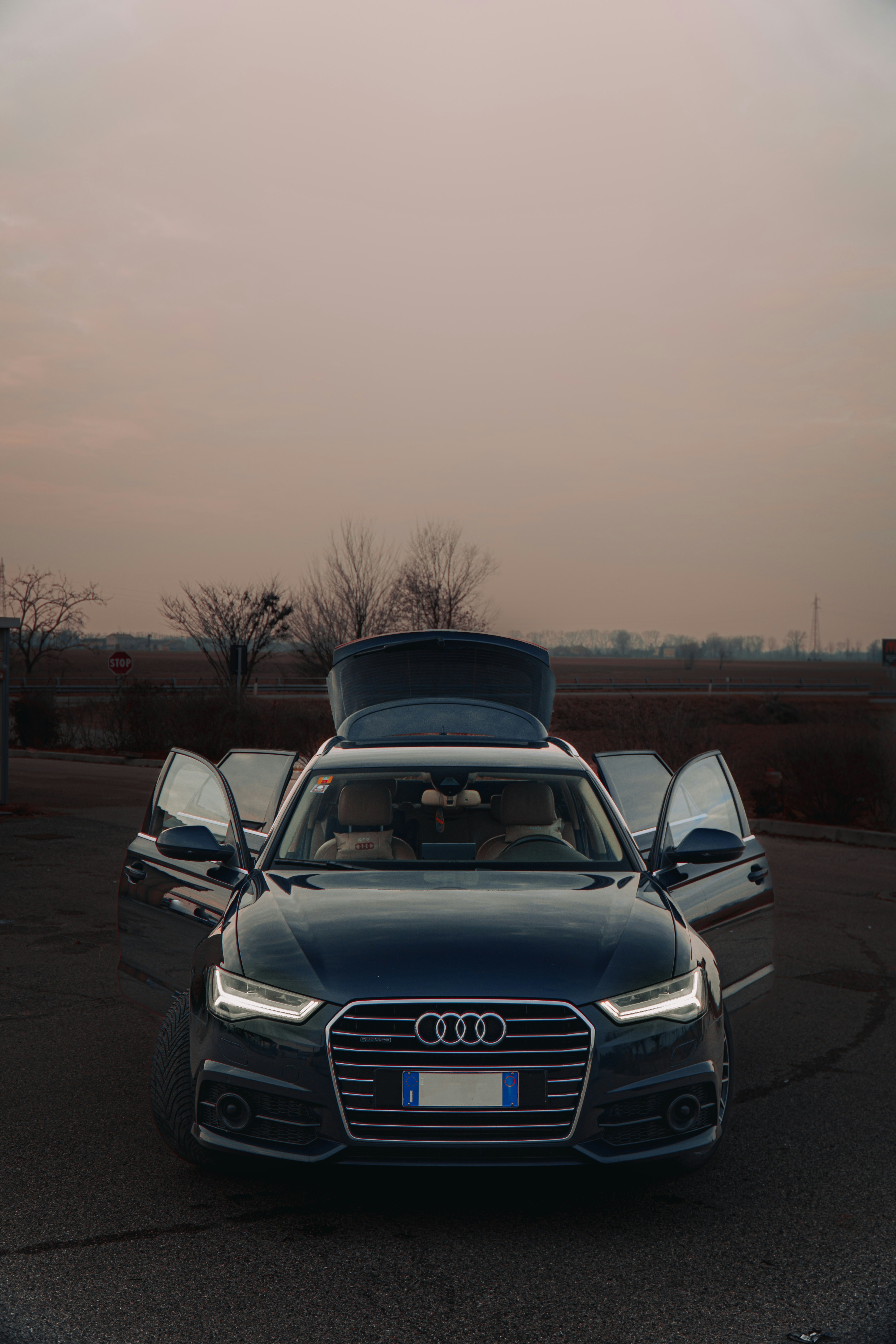 Dusk Portrait of an Audi: Doors Ajar in a Quiet Parking Lot