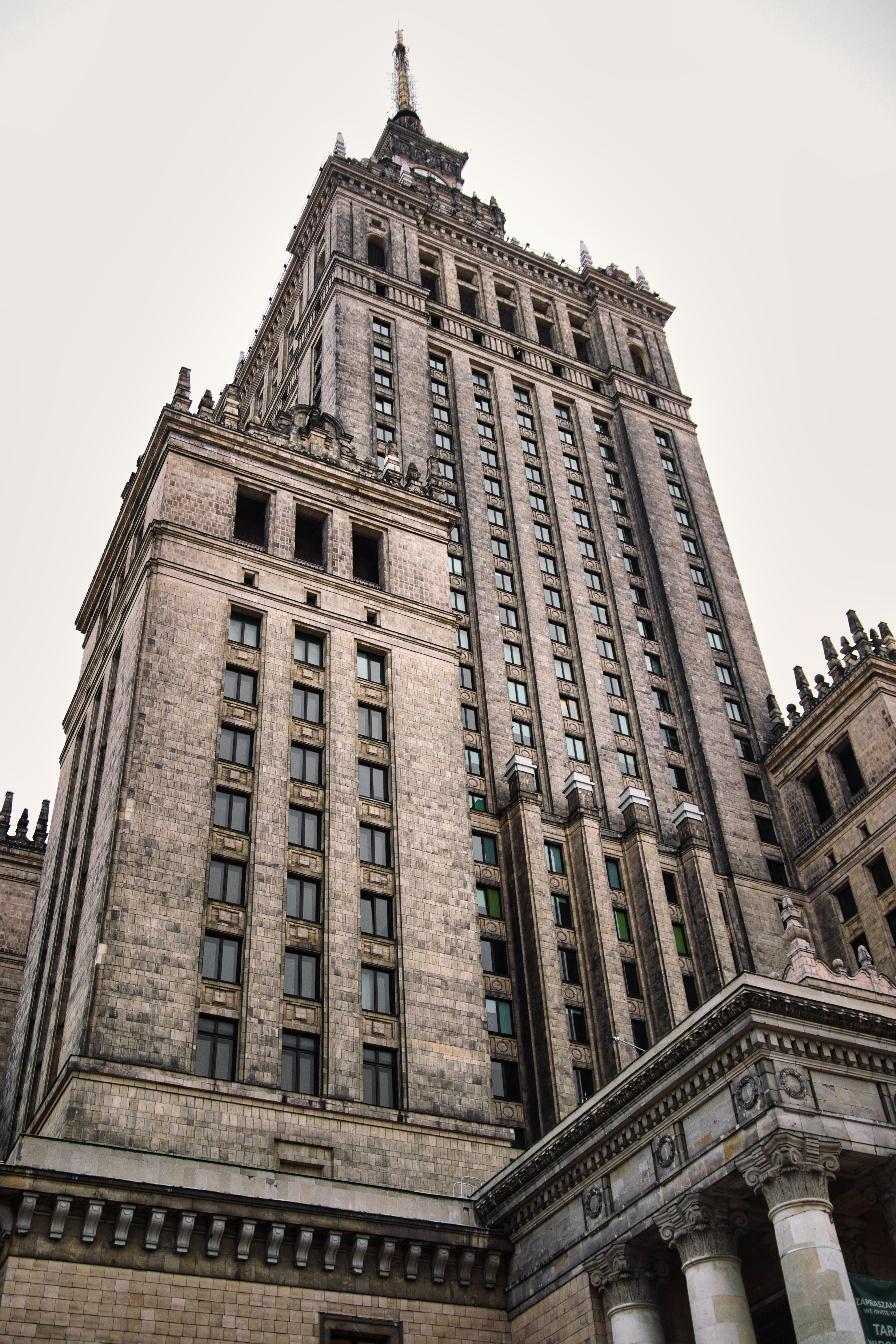 Imposing skyscraper showcasing intricate architectural details against a muted sky.
