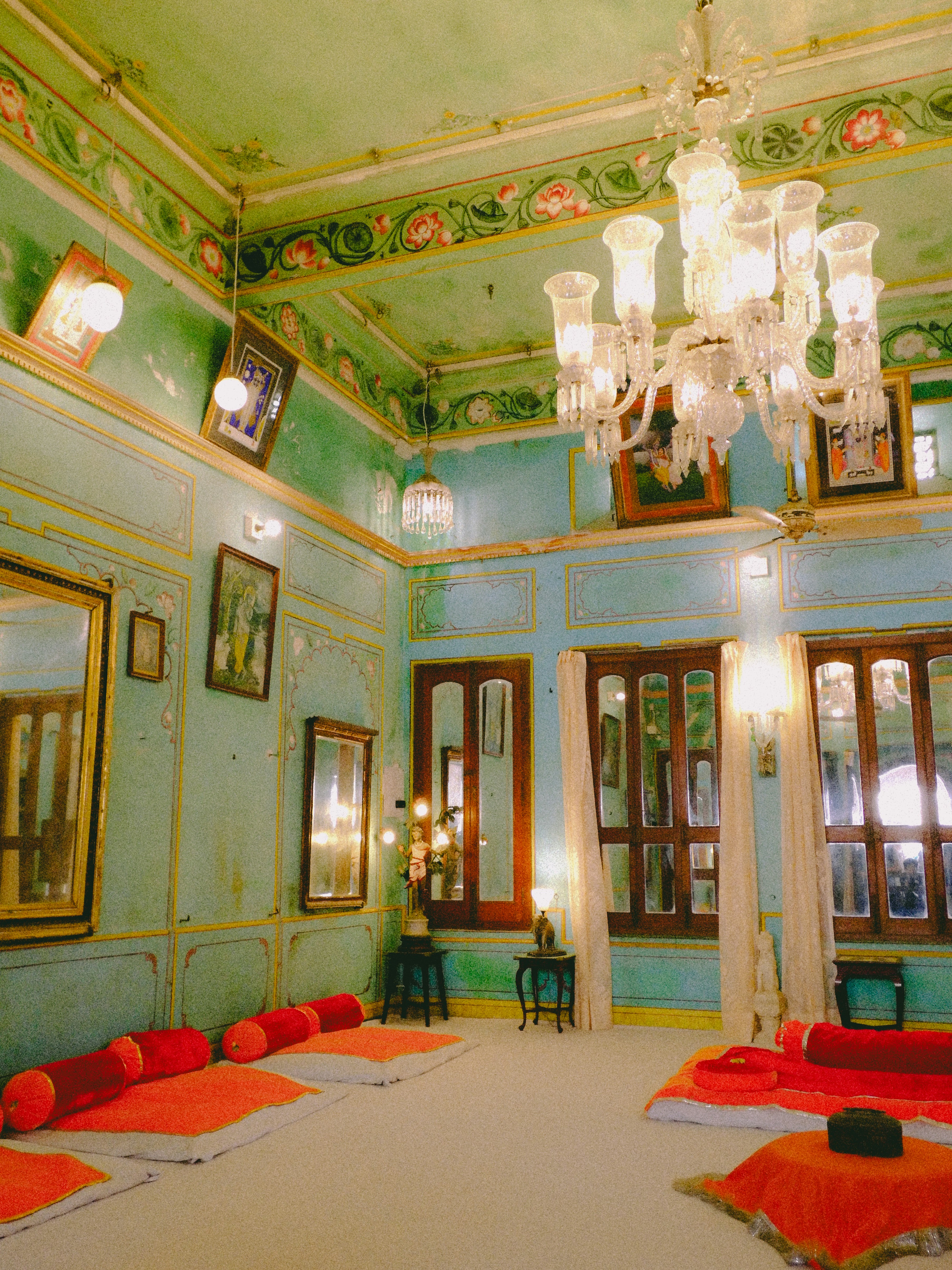 Ornate room with colorful walls and floor cushions