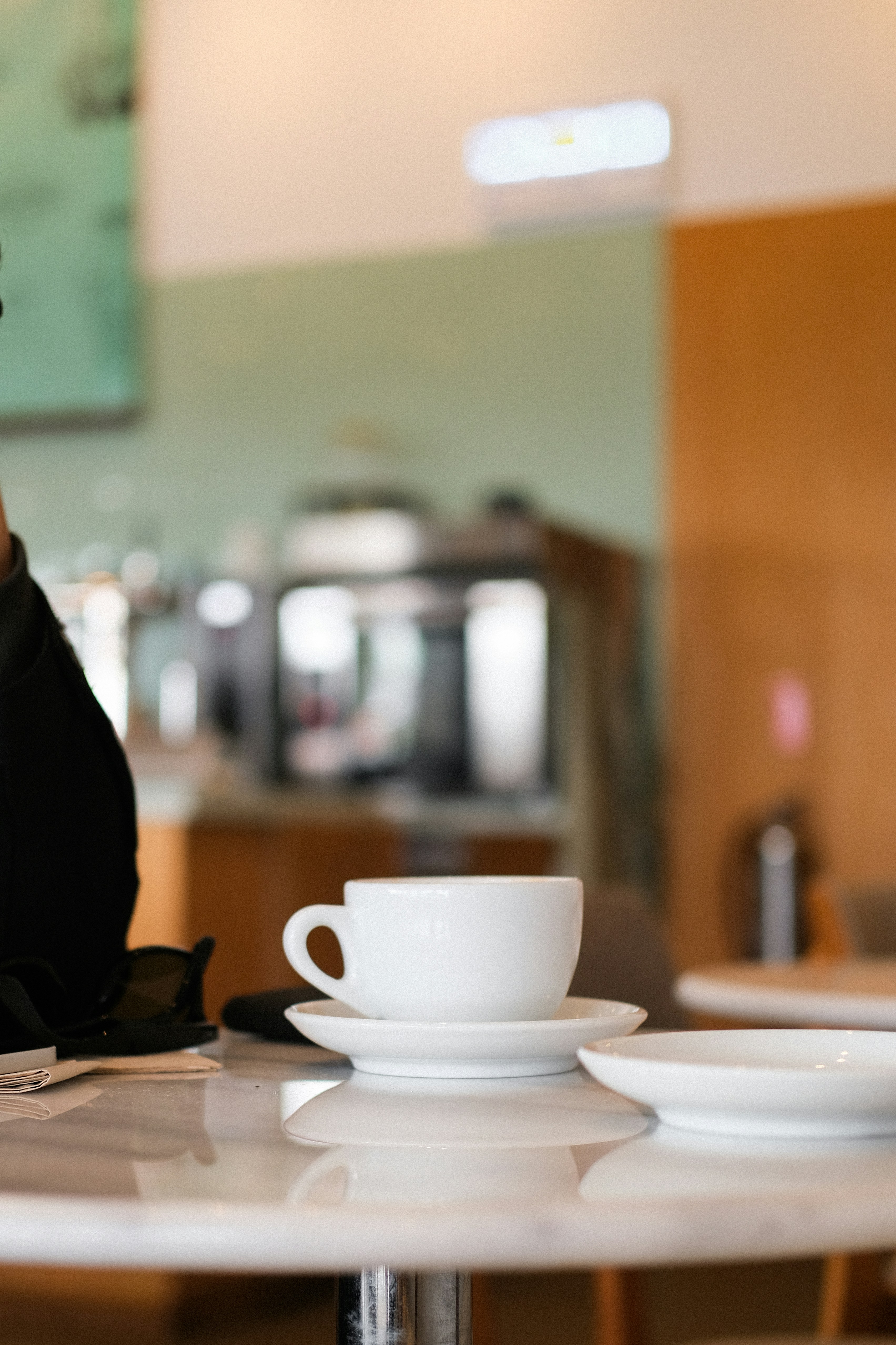 White coffee cup and saucer on marble table
