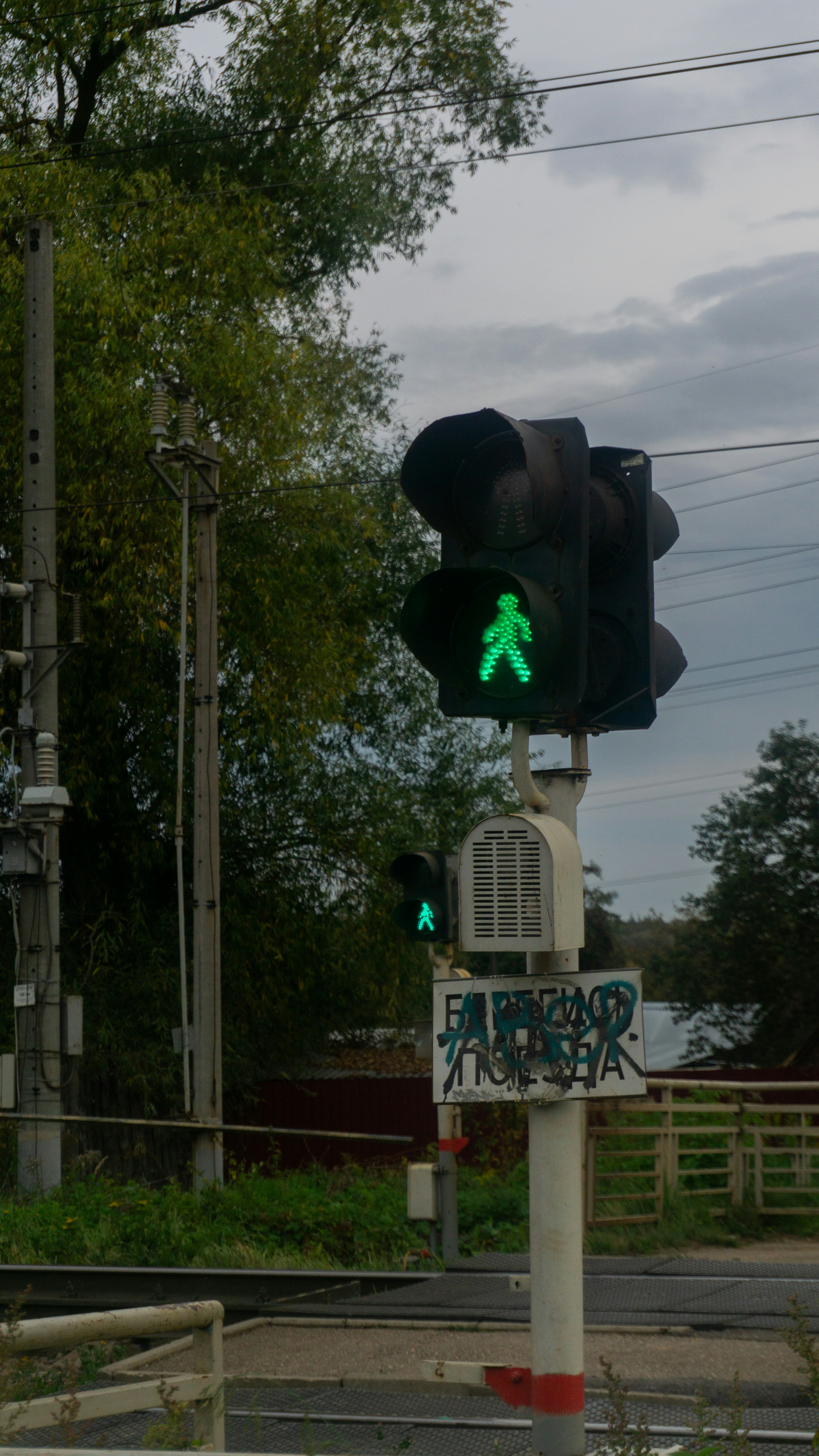 A pedestrian crossing signal shows a green walking person.