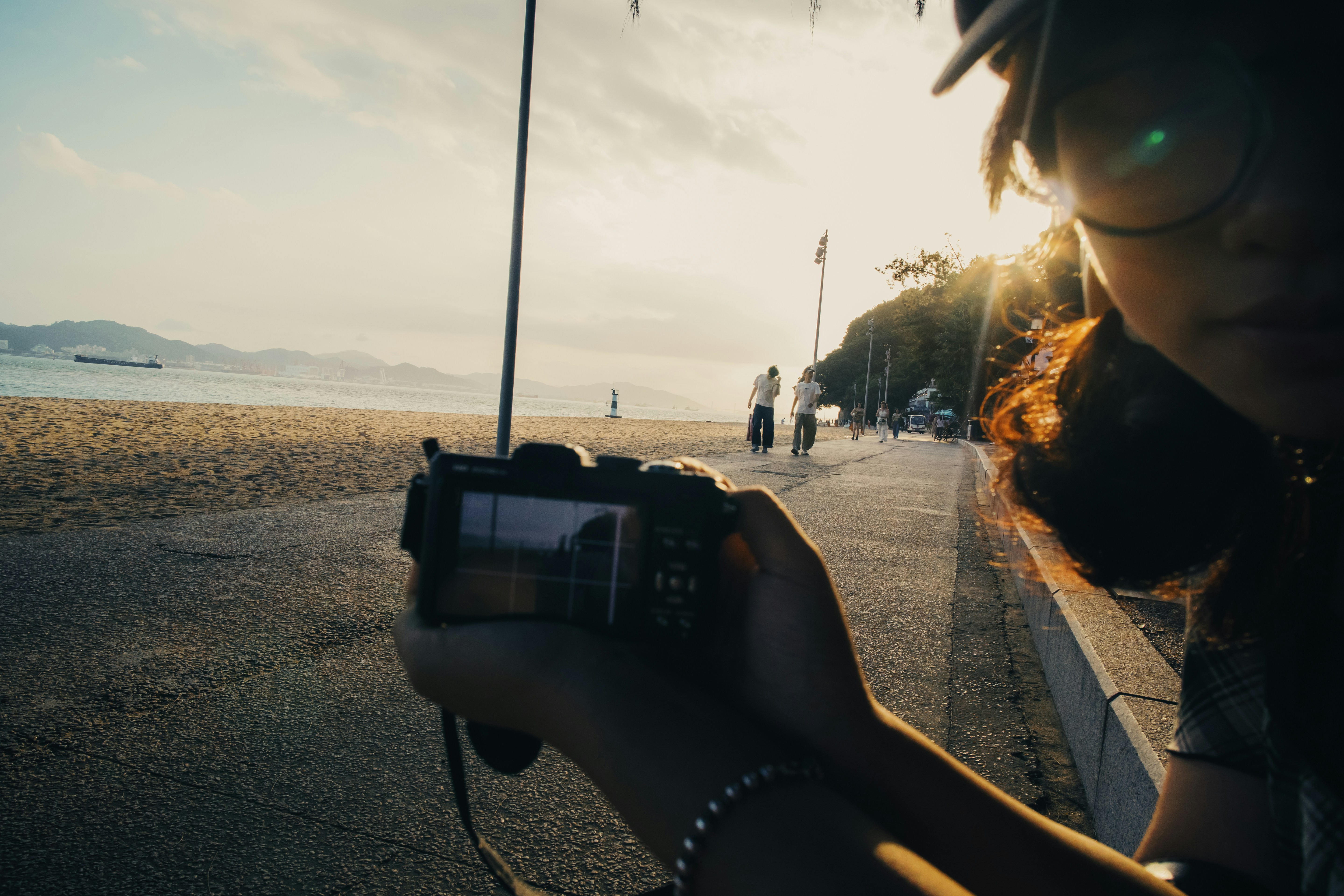 Backlit Beachfront Portrait: Handheld Shot Through a Viewfinder at Sunset