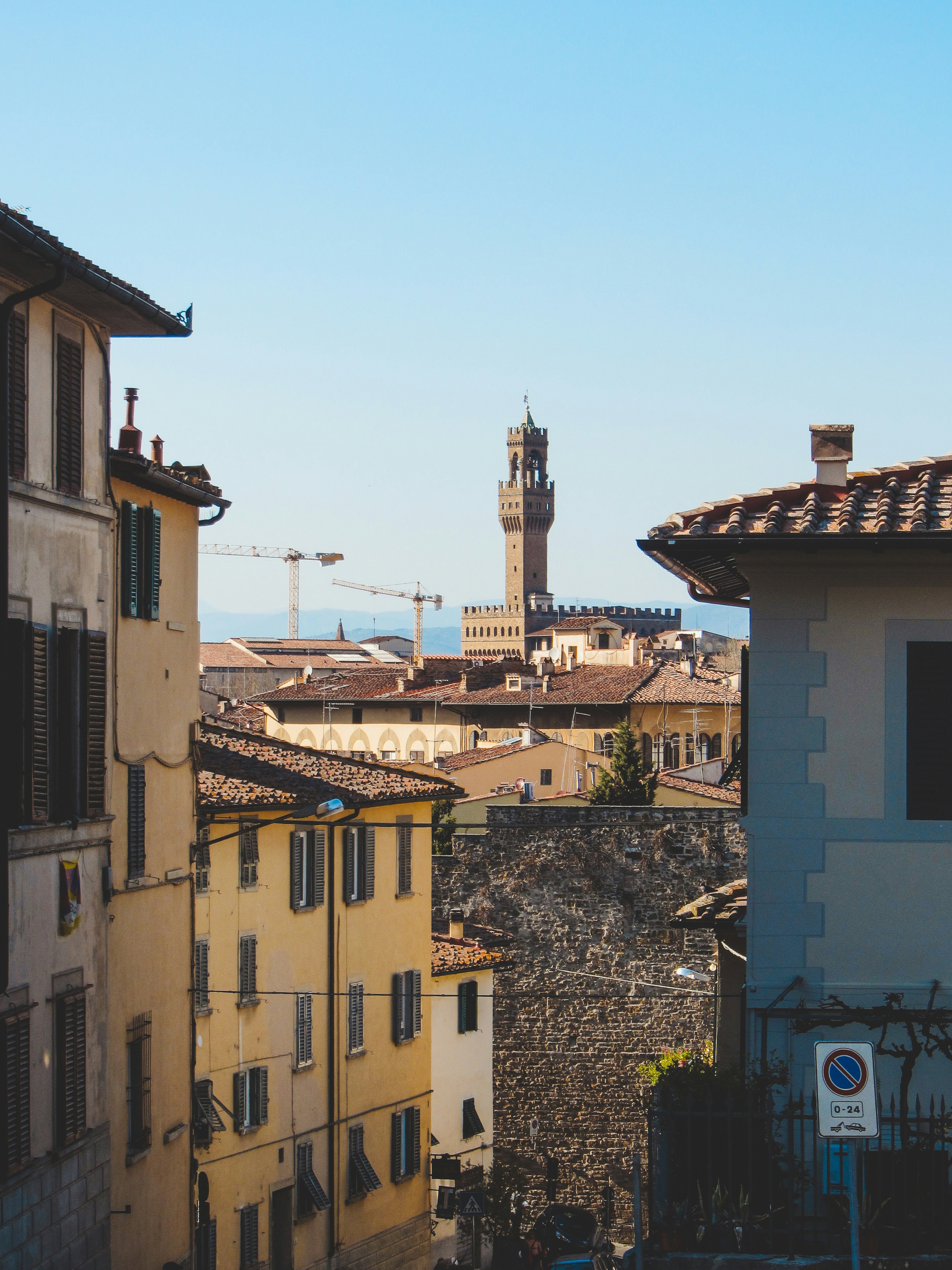 Palazzo Vecchio over Florentine rooftops | Historic italian cityscape with a tall tower in the distance.