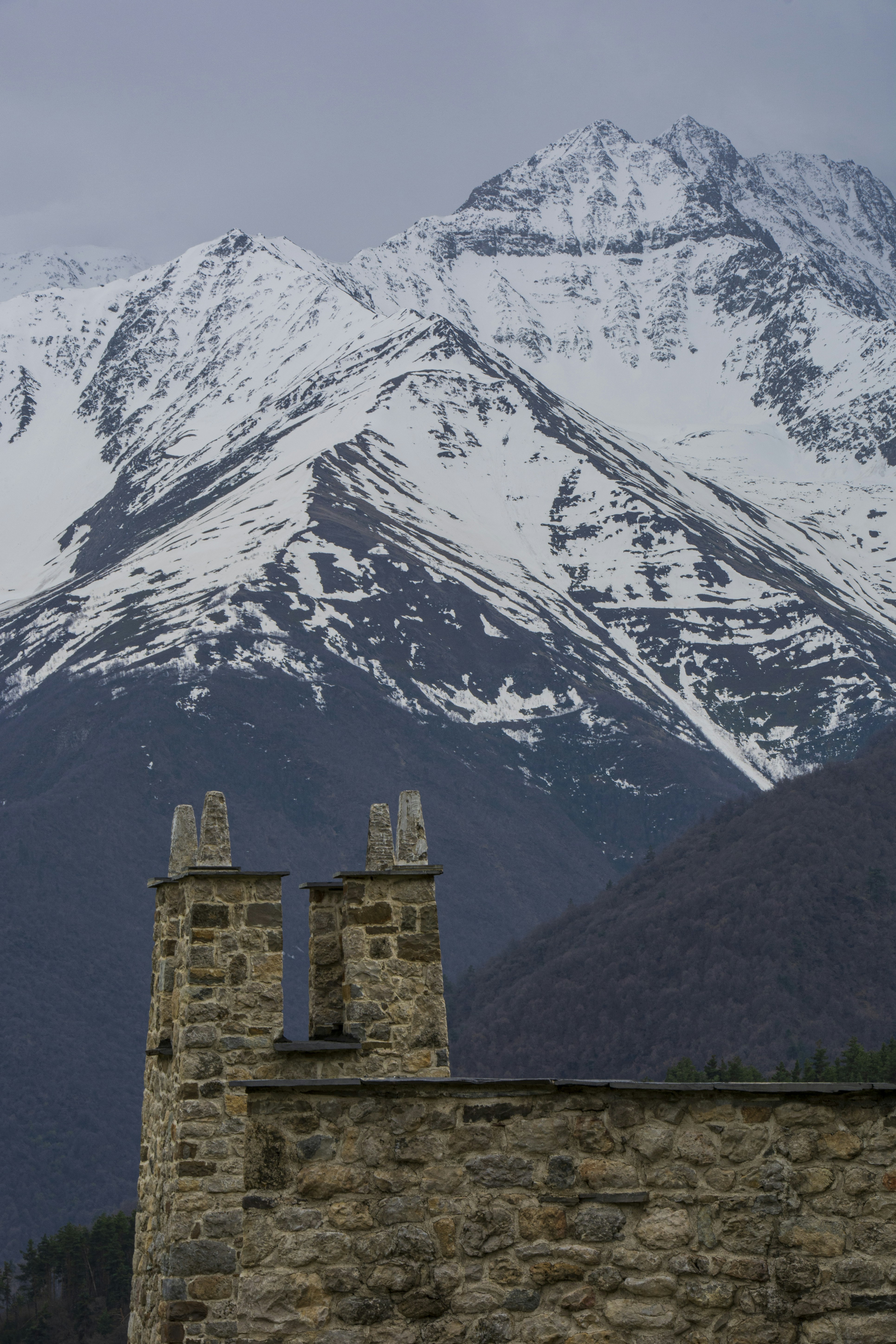 Echoes of Stone Against the Snow-Capped Giants