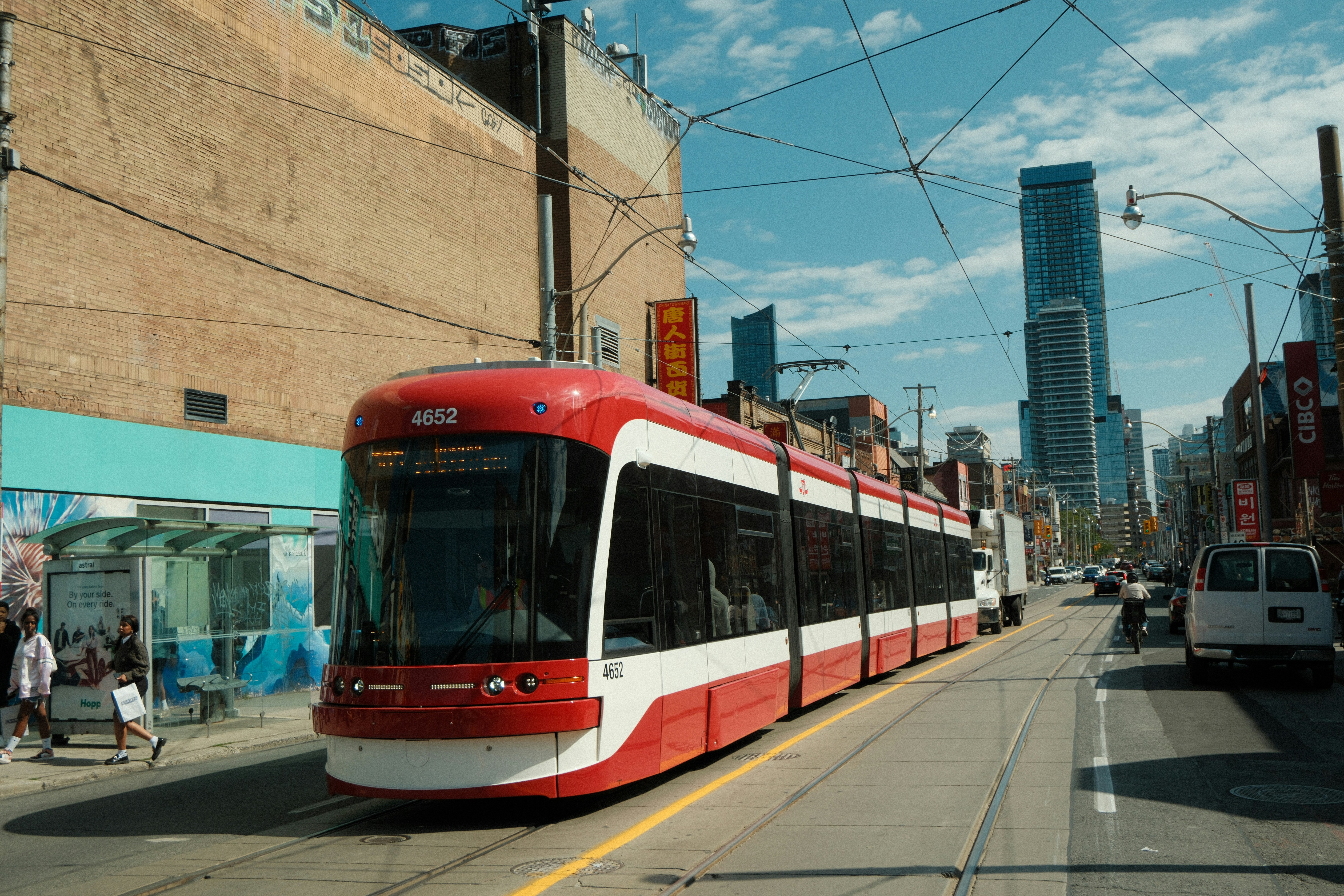 Red and white tram on a city street