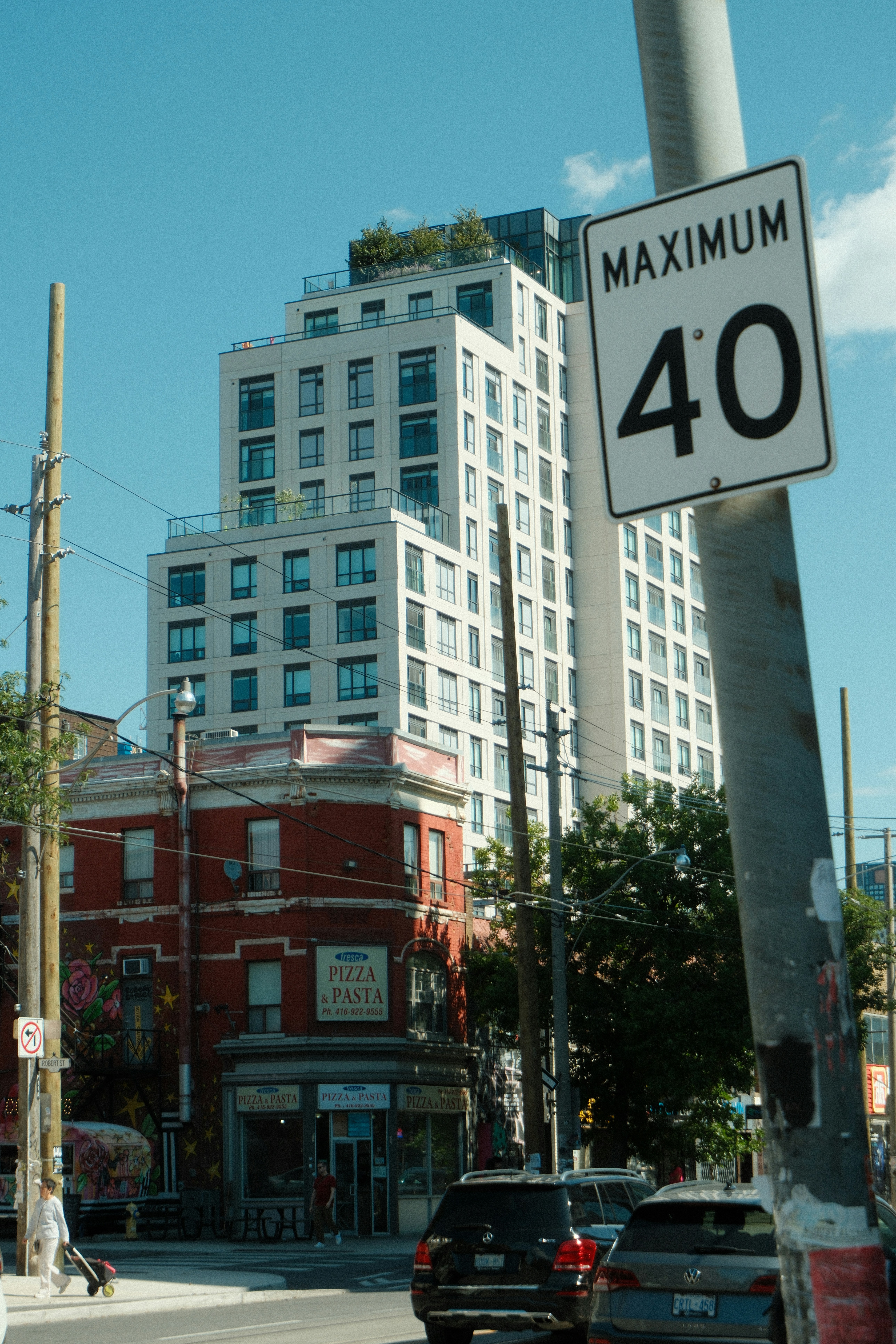 Tall modern buildings rise above red brick structures.