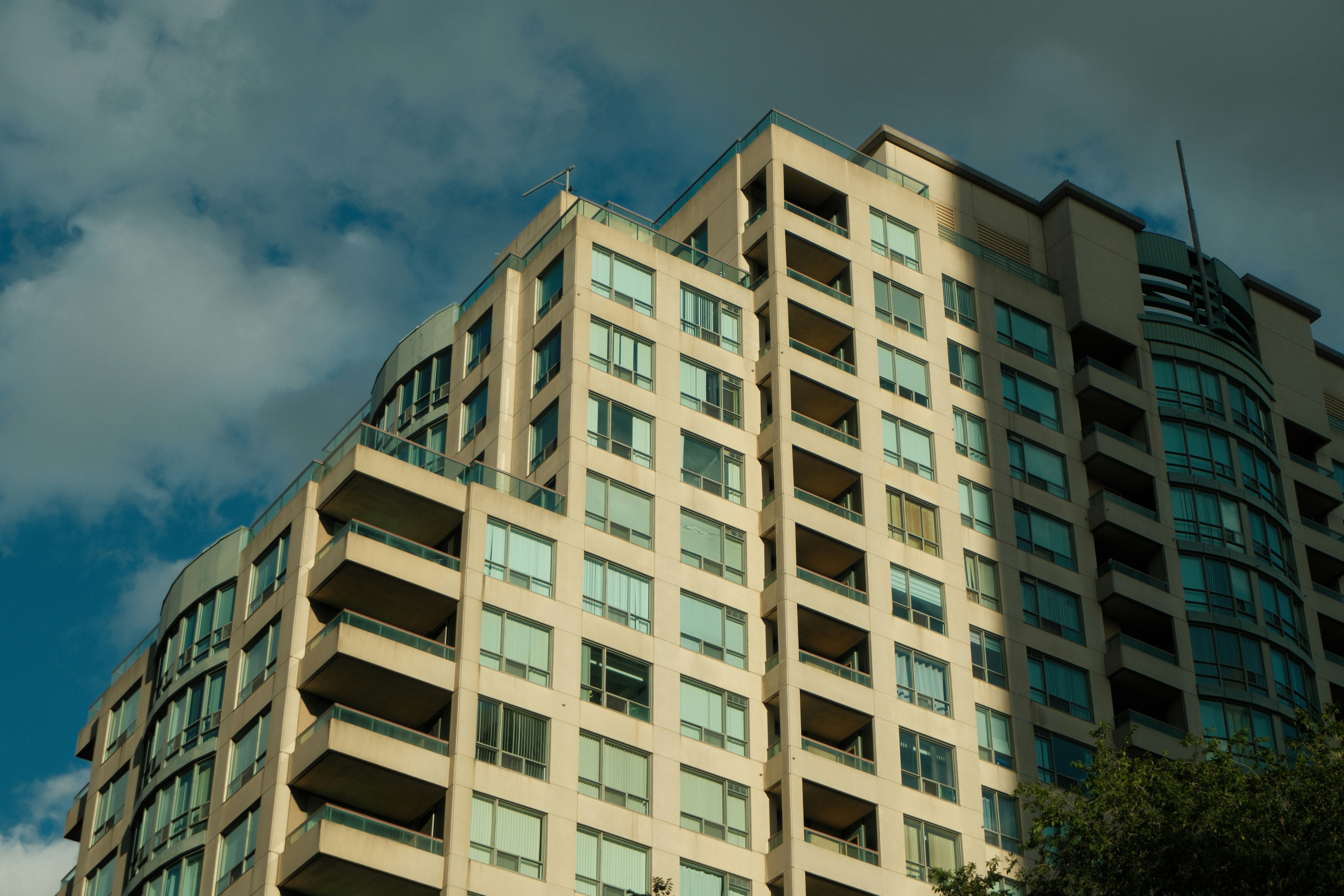Modern apartment building against a cloudy sky.