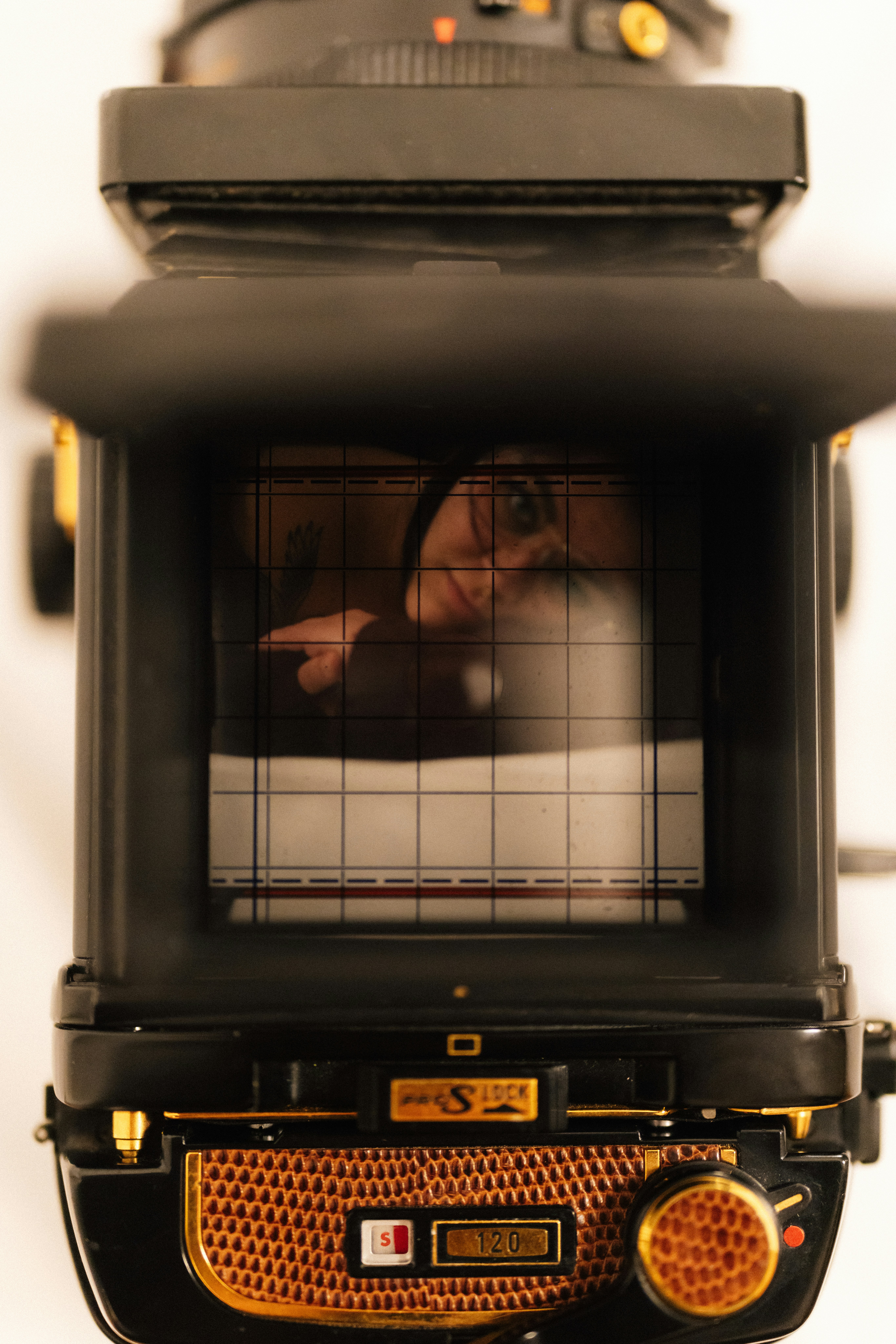 Viewfinder of a vintage camera showing a person's face.