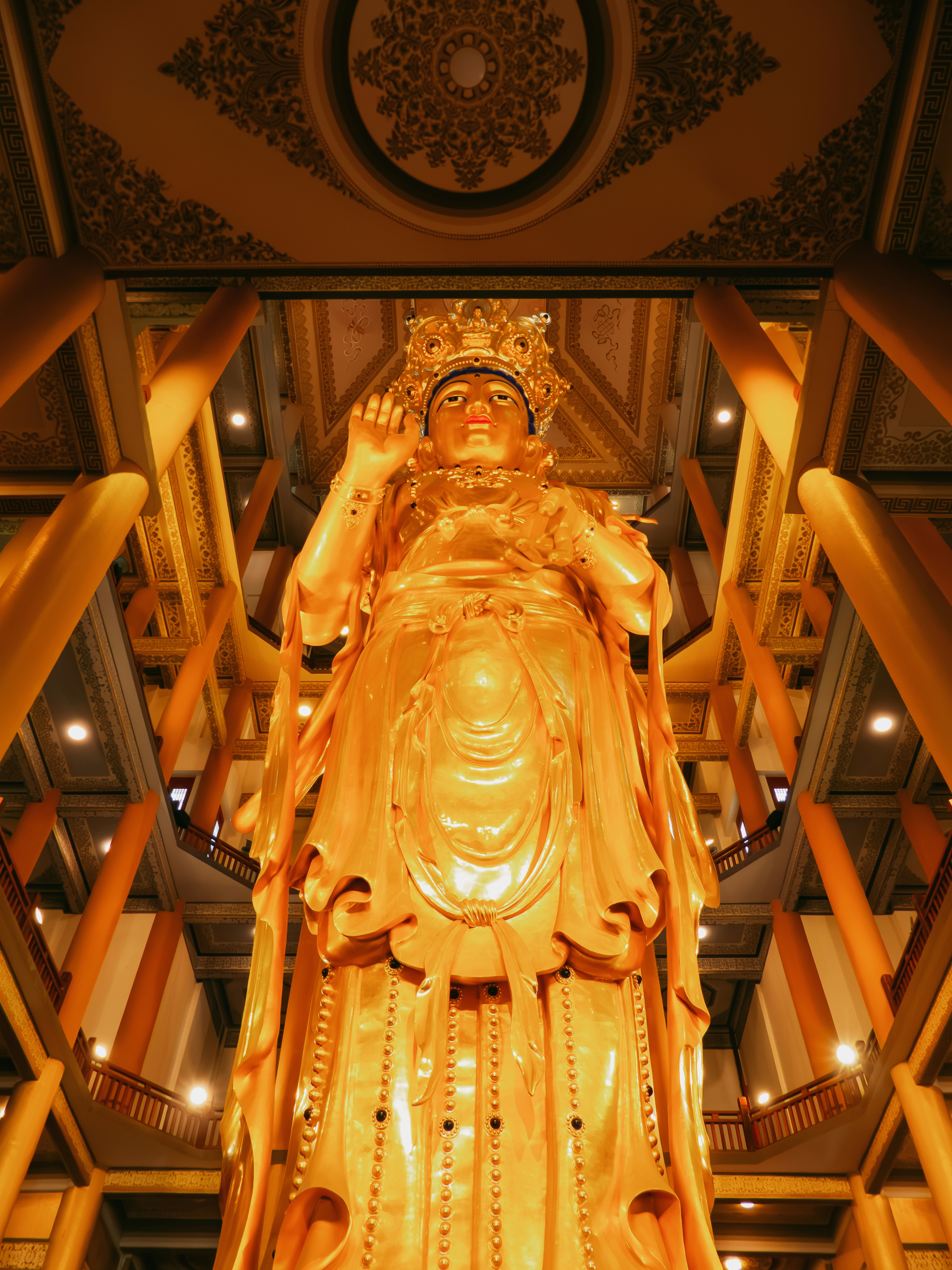 A towering golden statue inside a grand building.