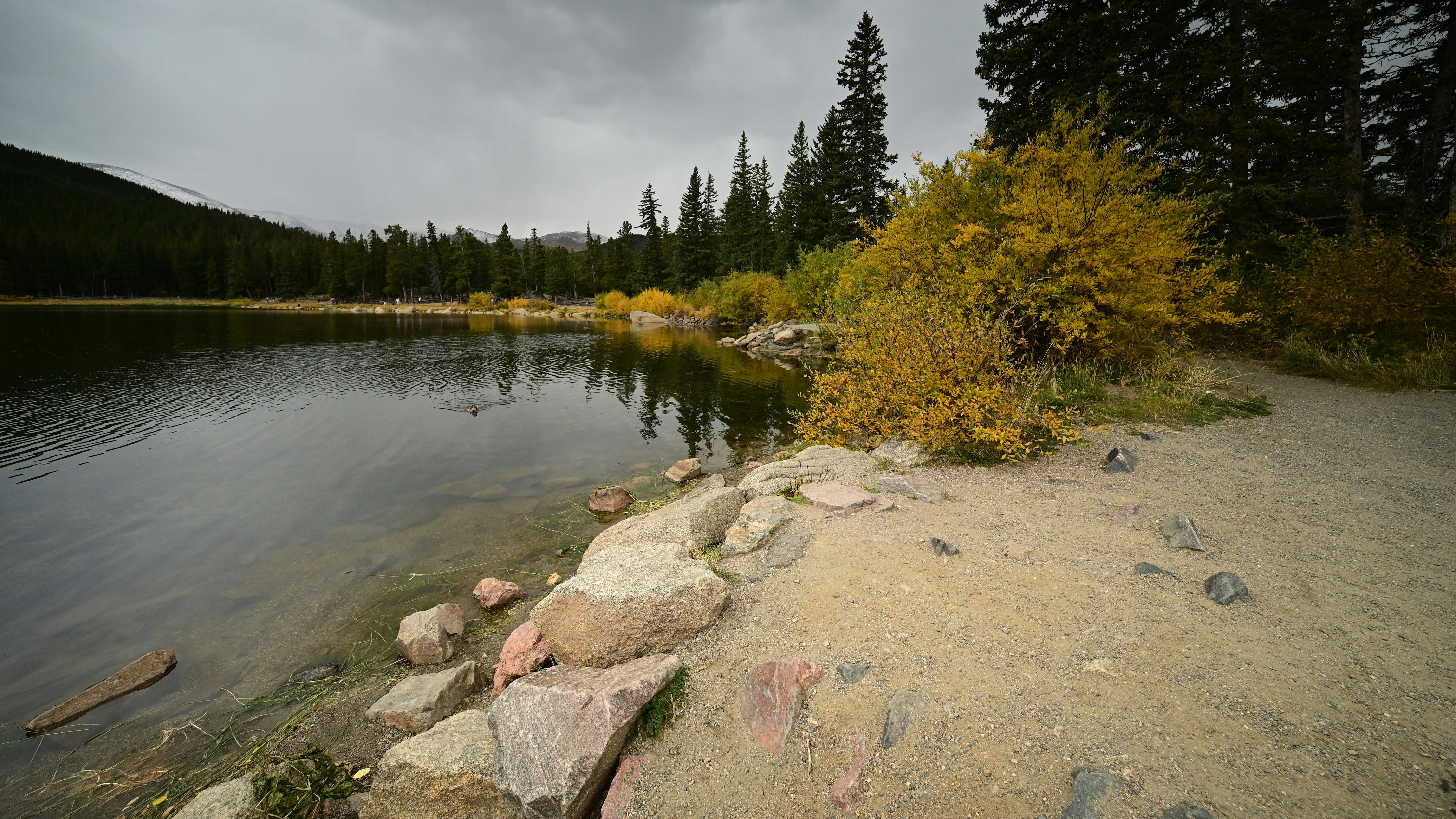 Lake with rocky shore and autumn foliage