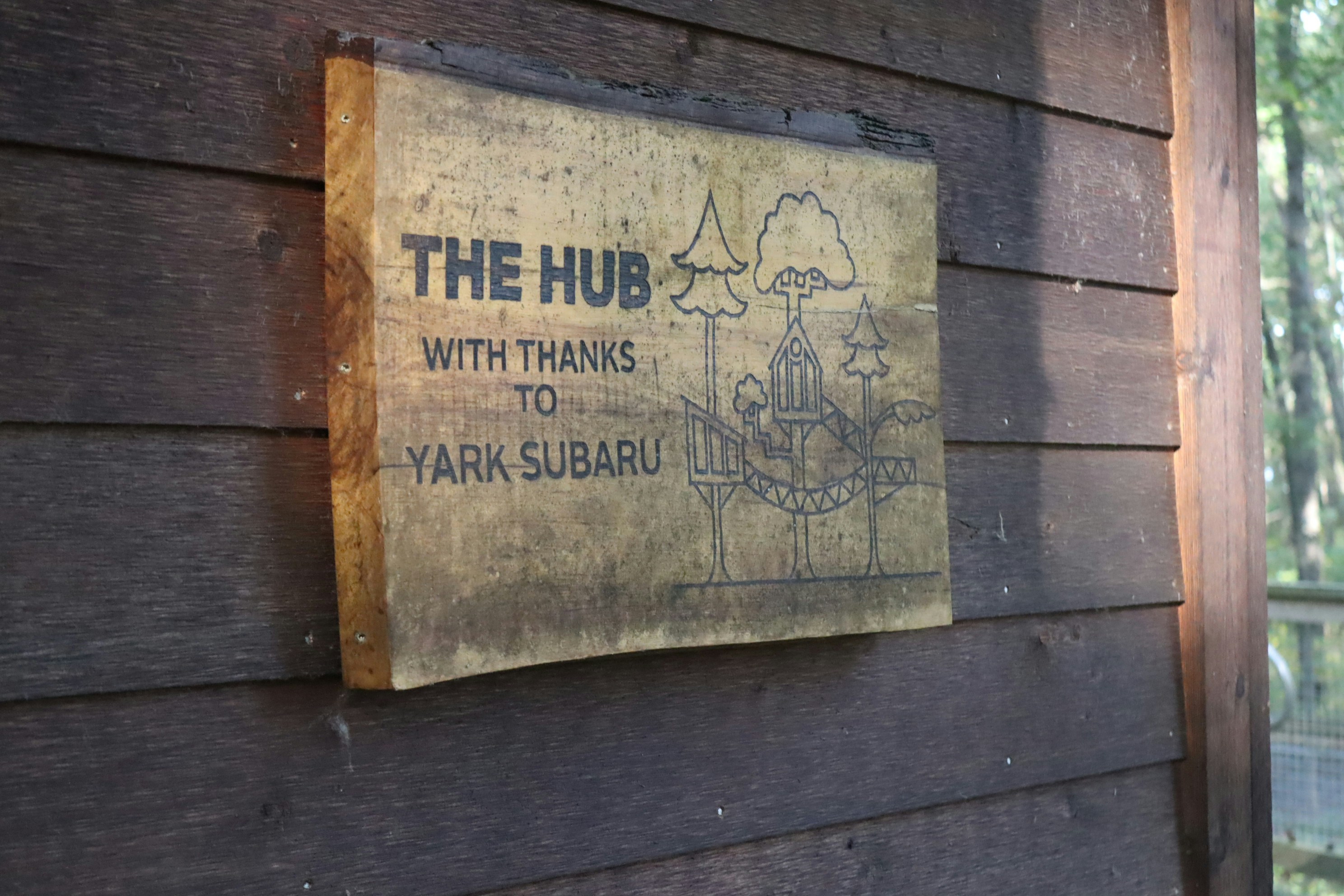 The hub sign mounted on a wooden wall