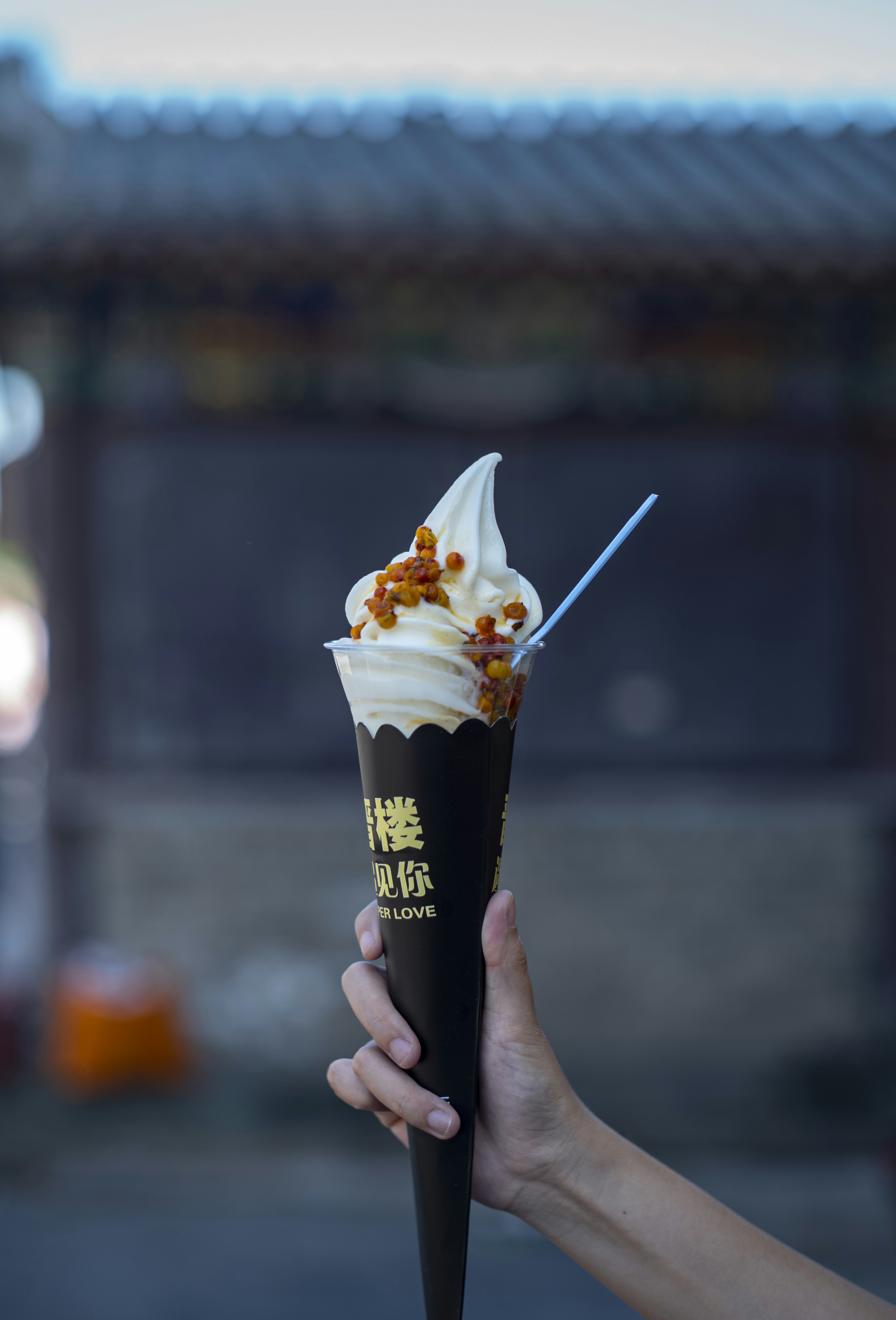 Vanilla soft serve ice cream cone with toppings