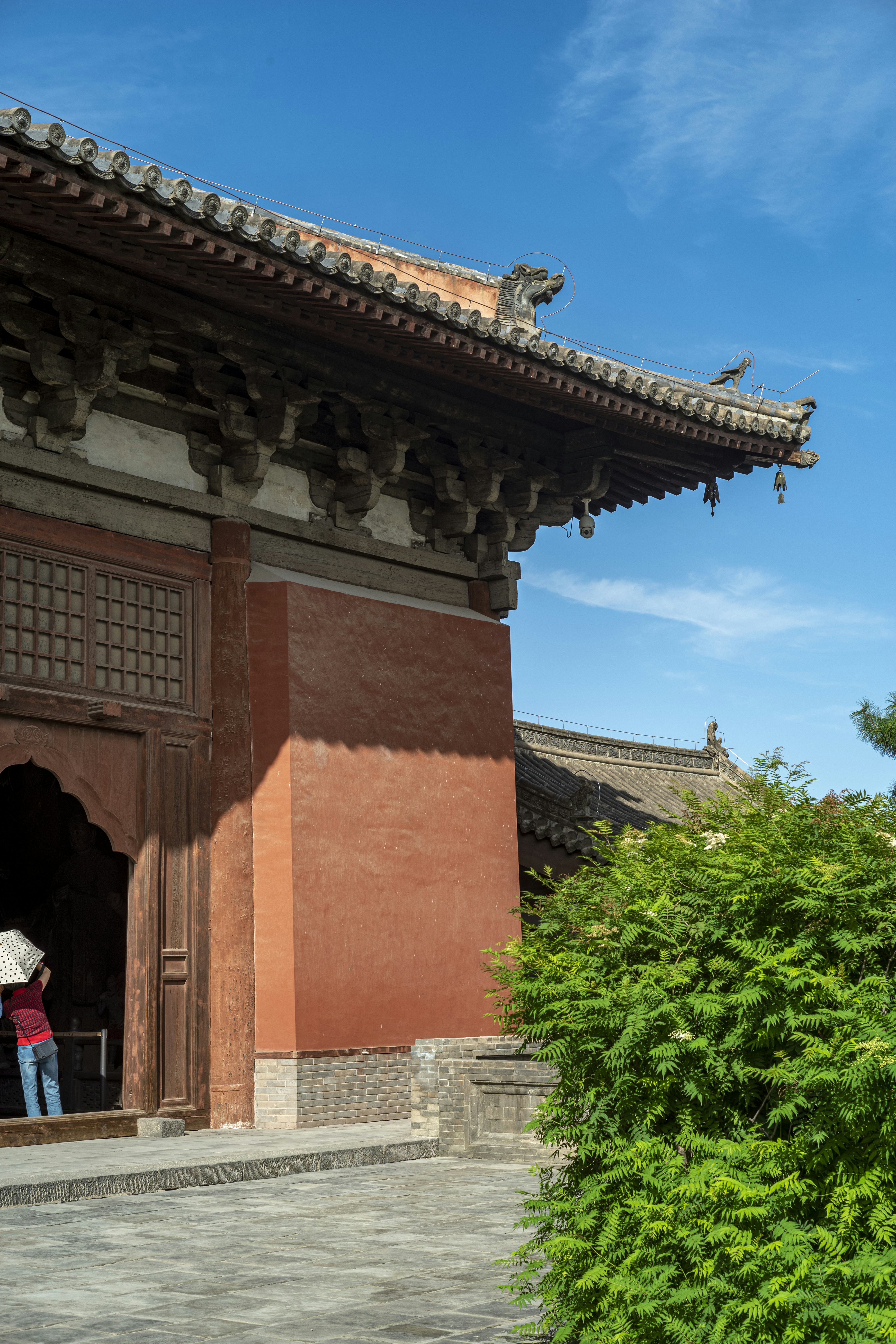 Dragon Crest over the Red Gate: Sunlit Eaves of a Traditional Chinese Courtyard
