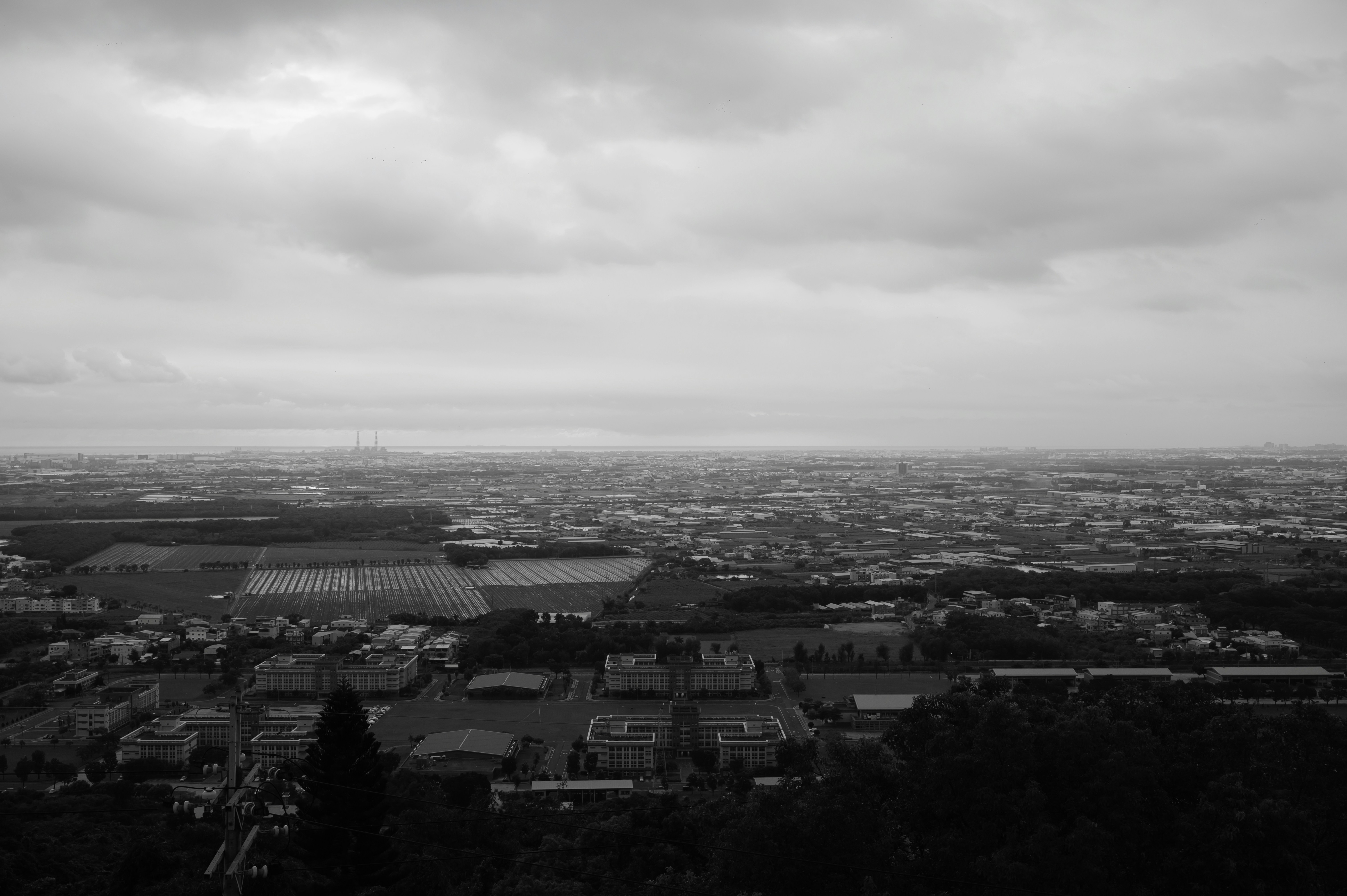 Overcast sky above a sprawling city landscape.