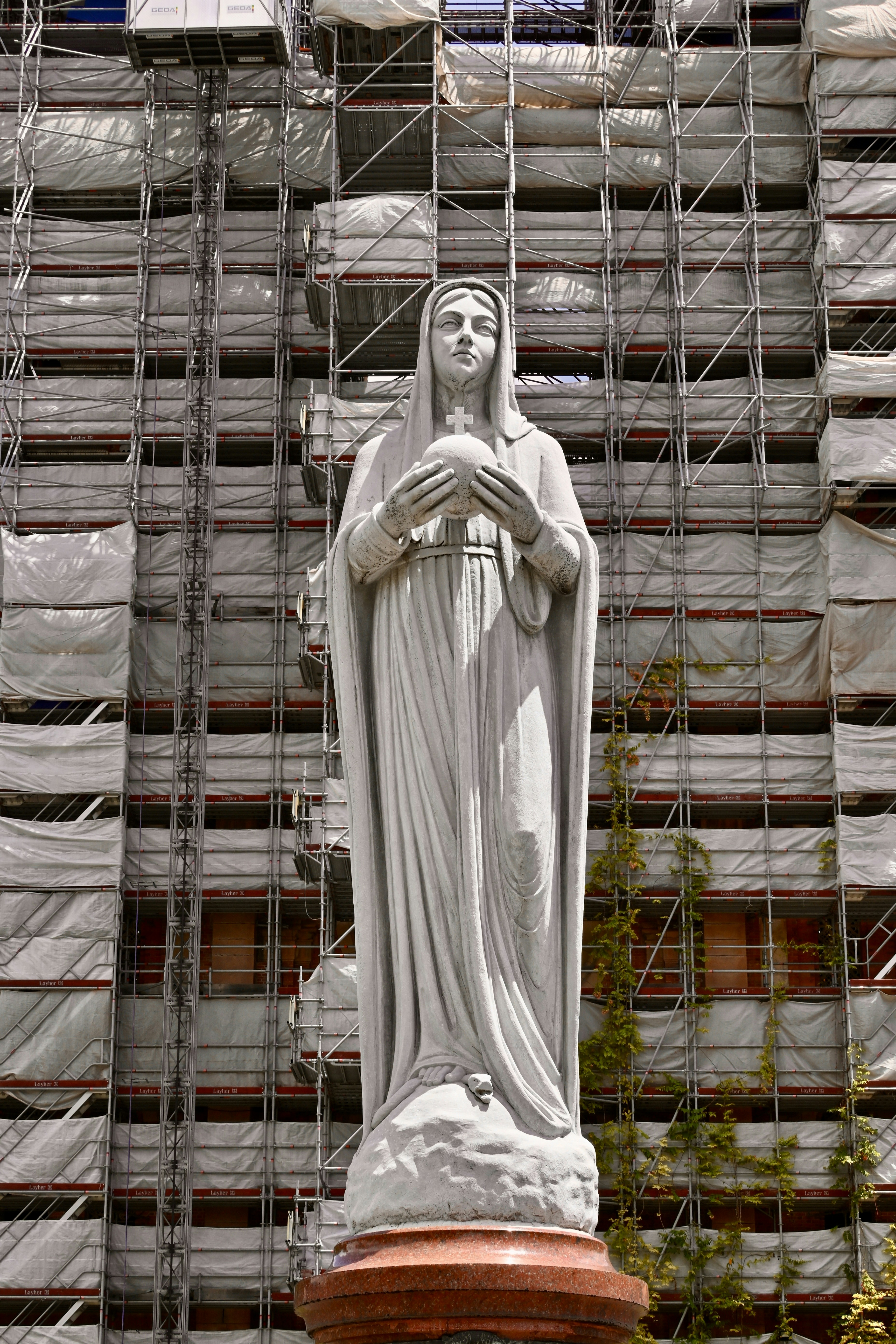 Guardian of Renewal: A Statue Amidst Construction