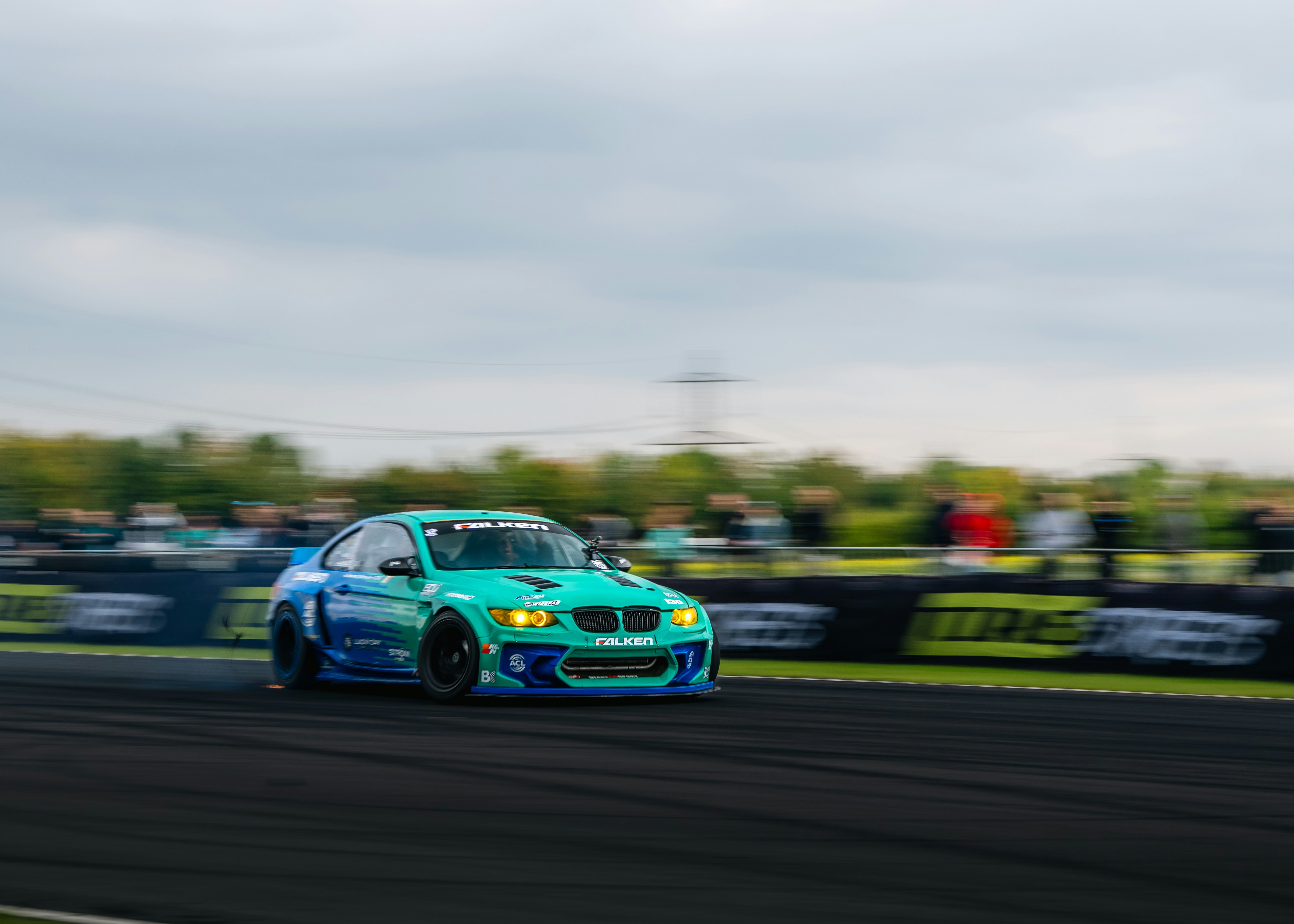 Blue race car speeding on track with blurred background