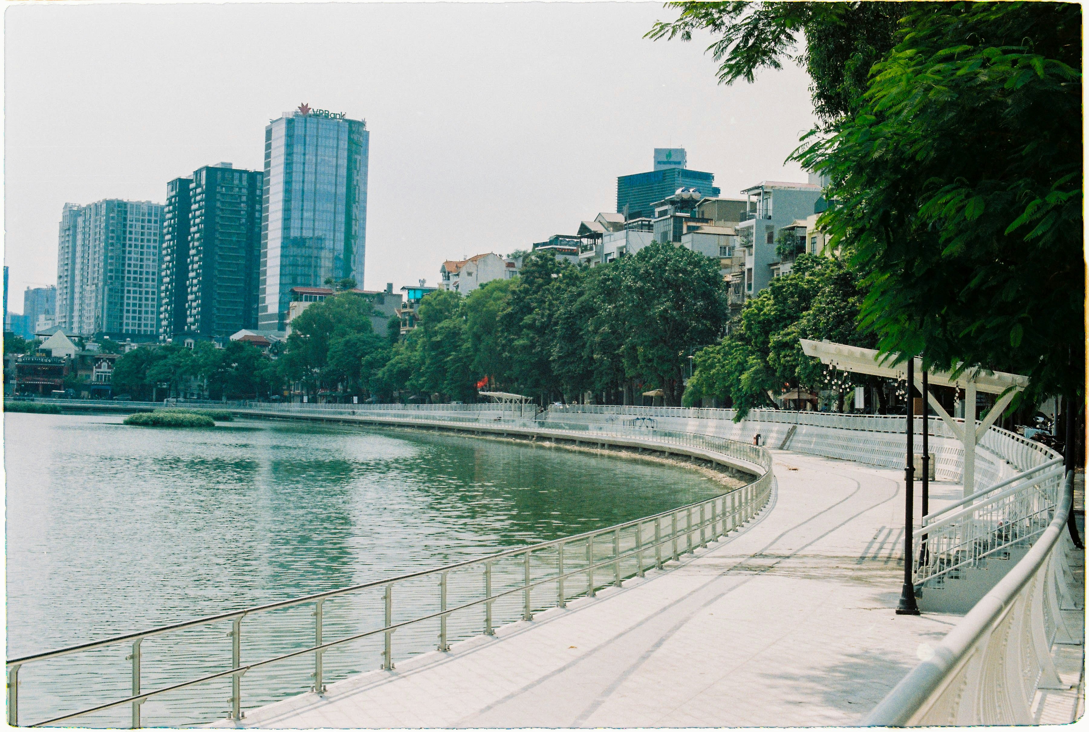 City skyline with lake and walking path