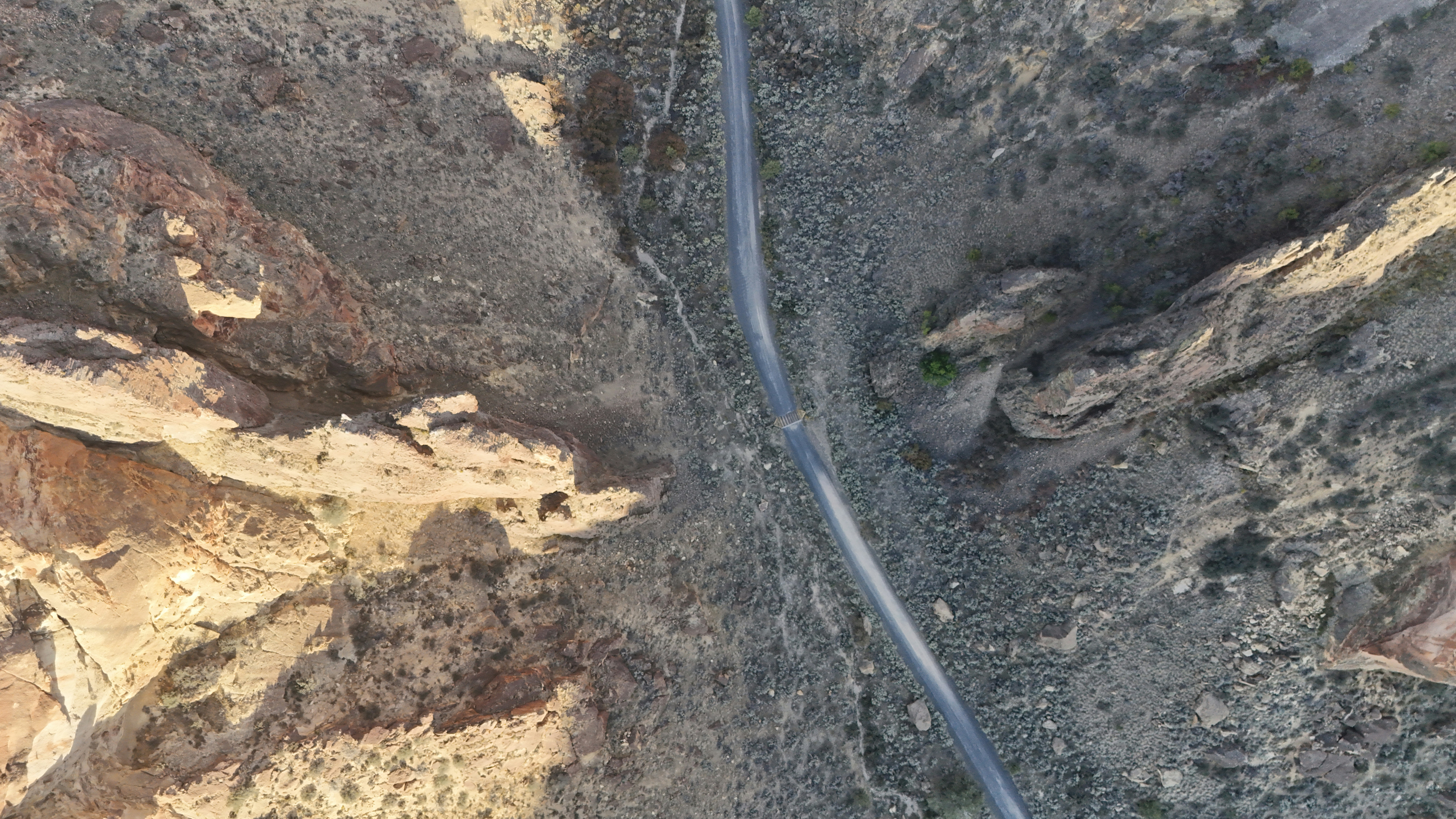 Aerial view of a narrow road through rocky desert terrain. photo – Free ...