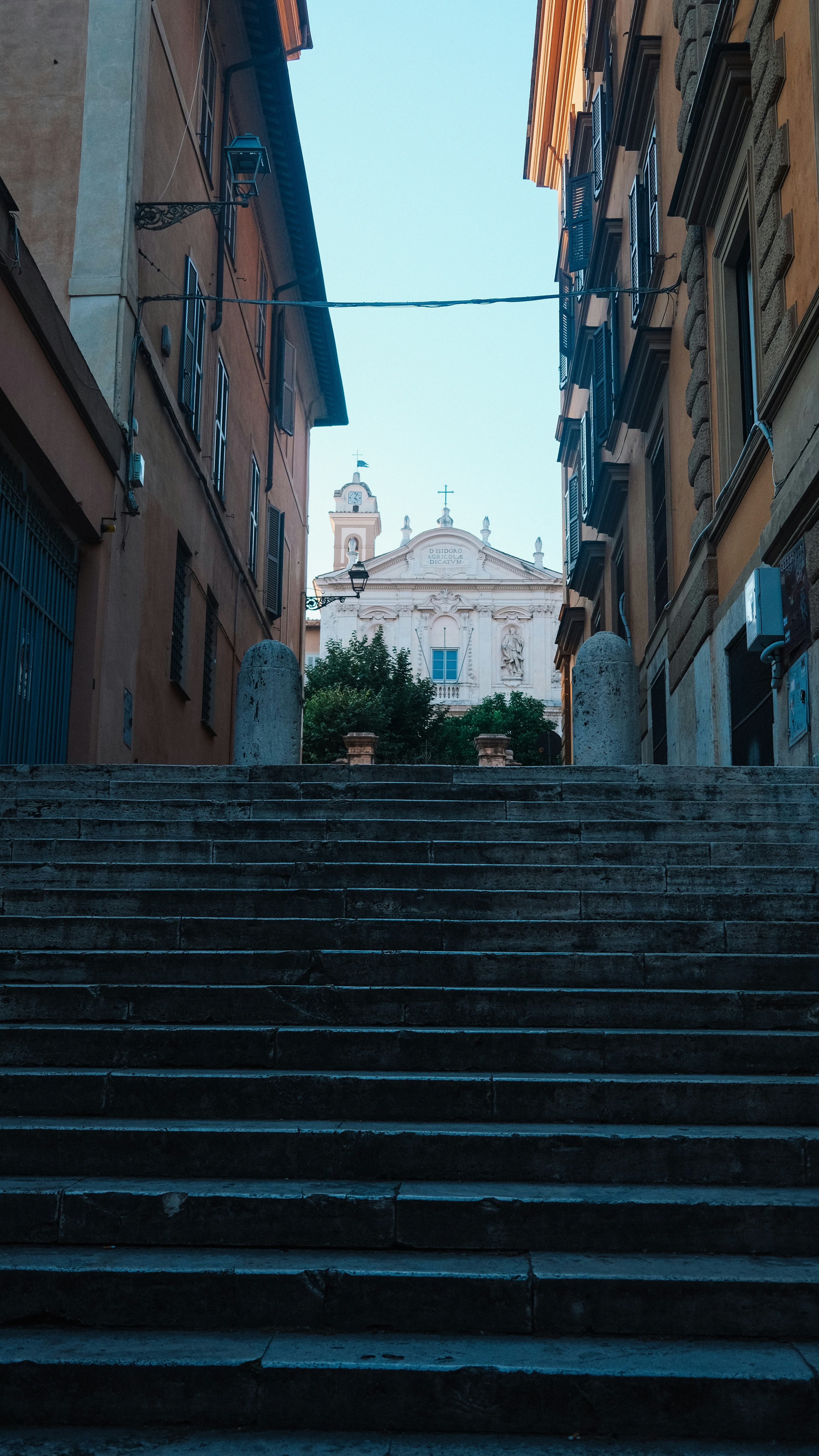 Stone steps lead to a church between buildings.