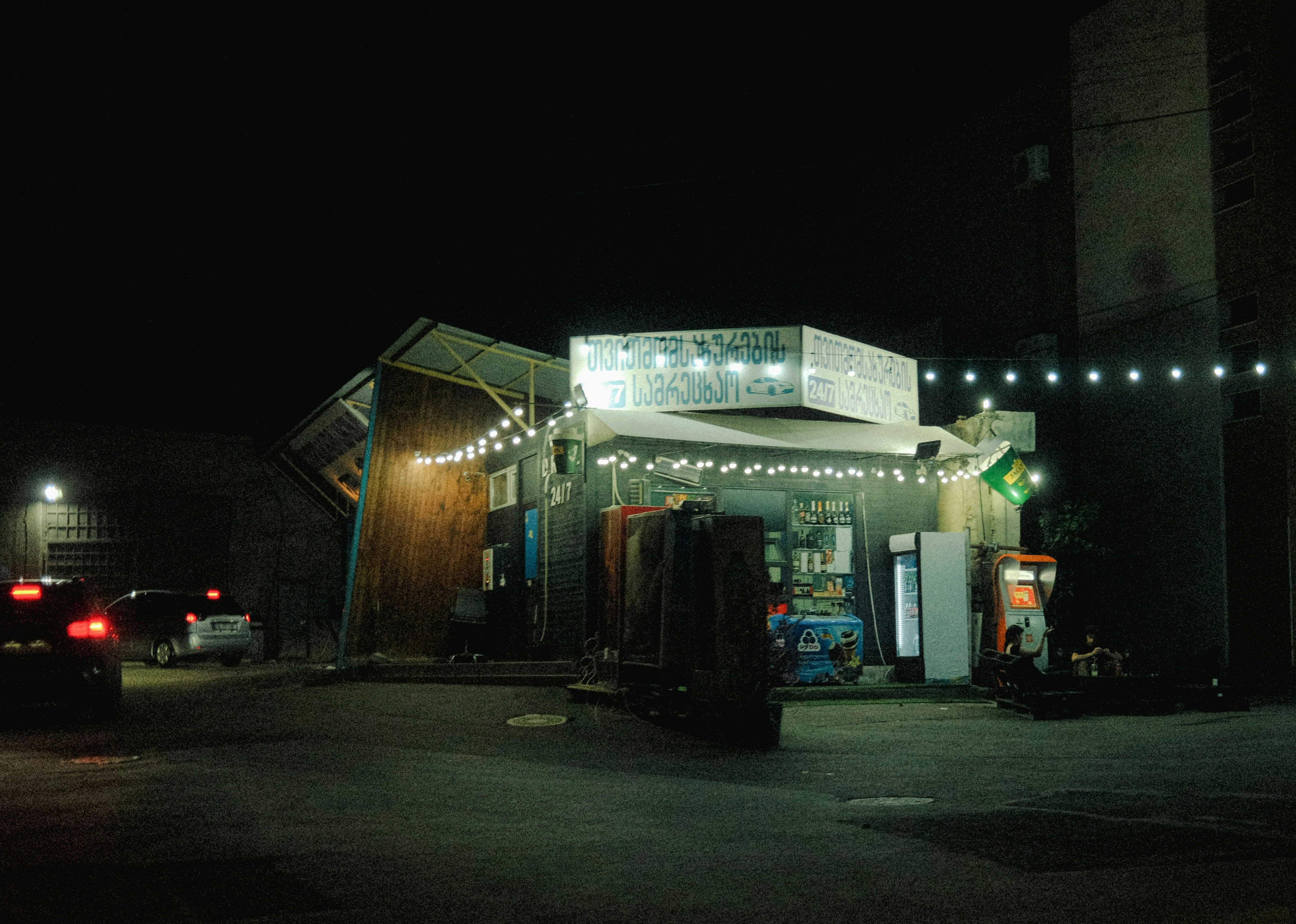 Tbilisi, September 2025. | A modern building at night with string lights.