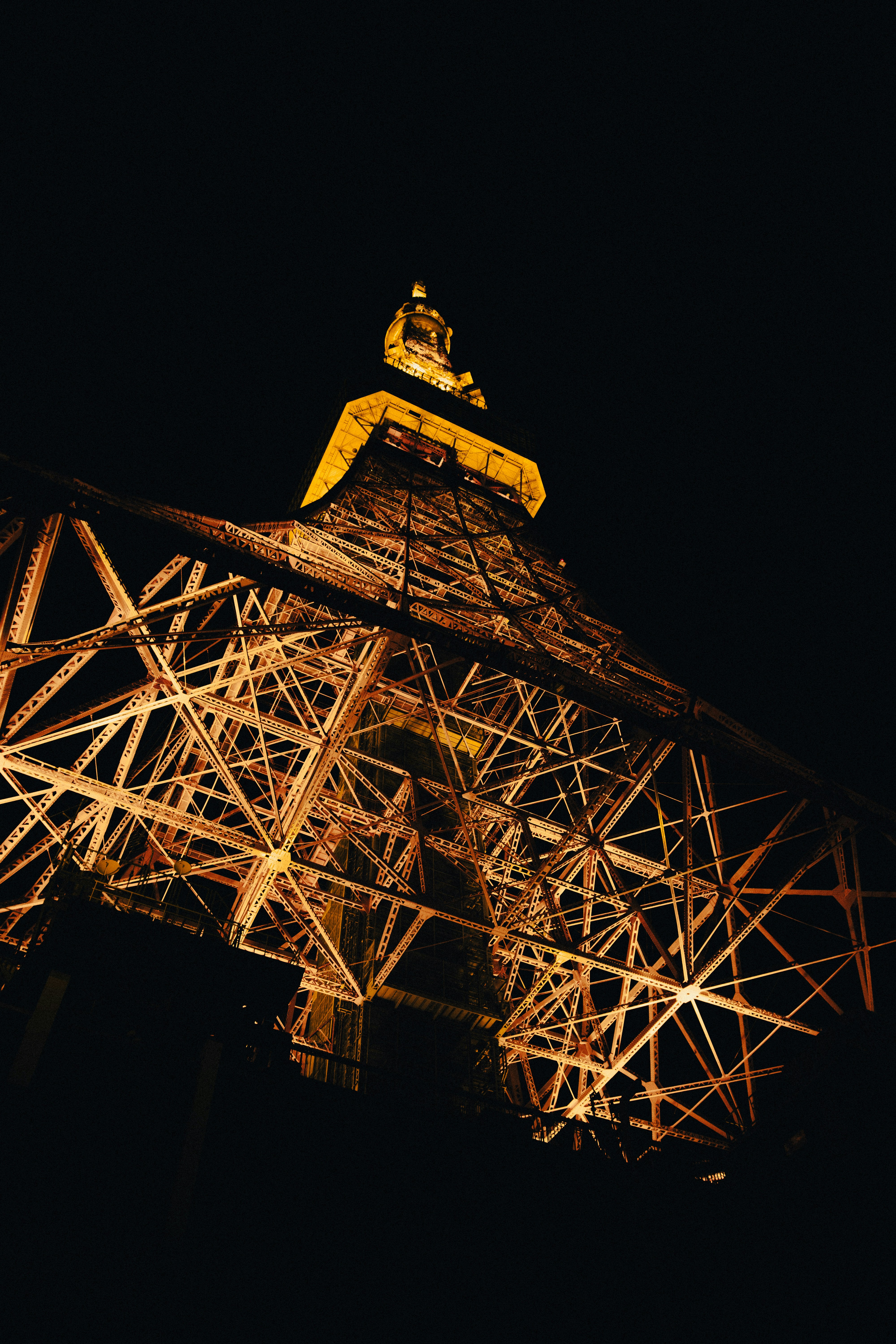 Illuminated tokyo tower structure against dark night sky