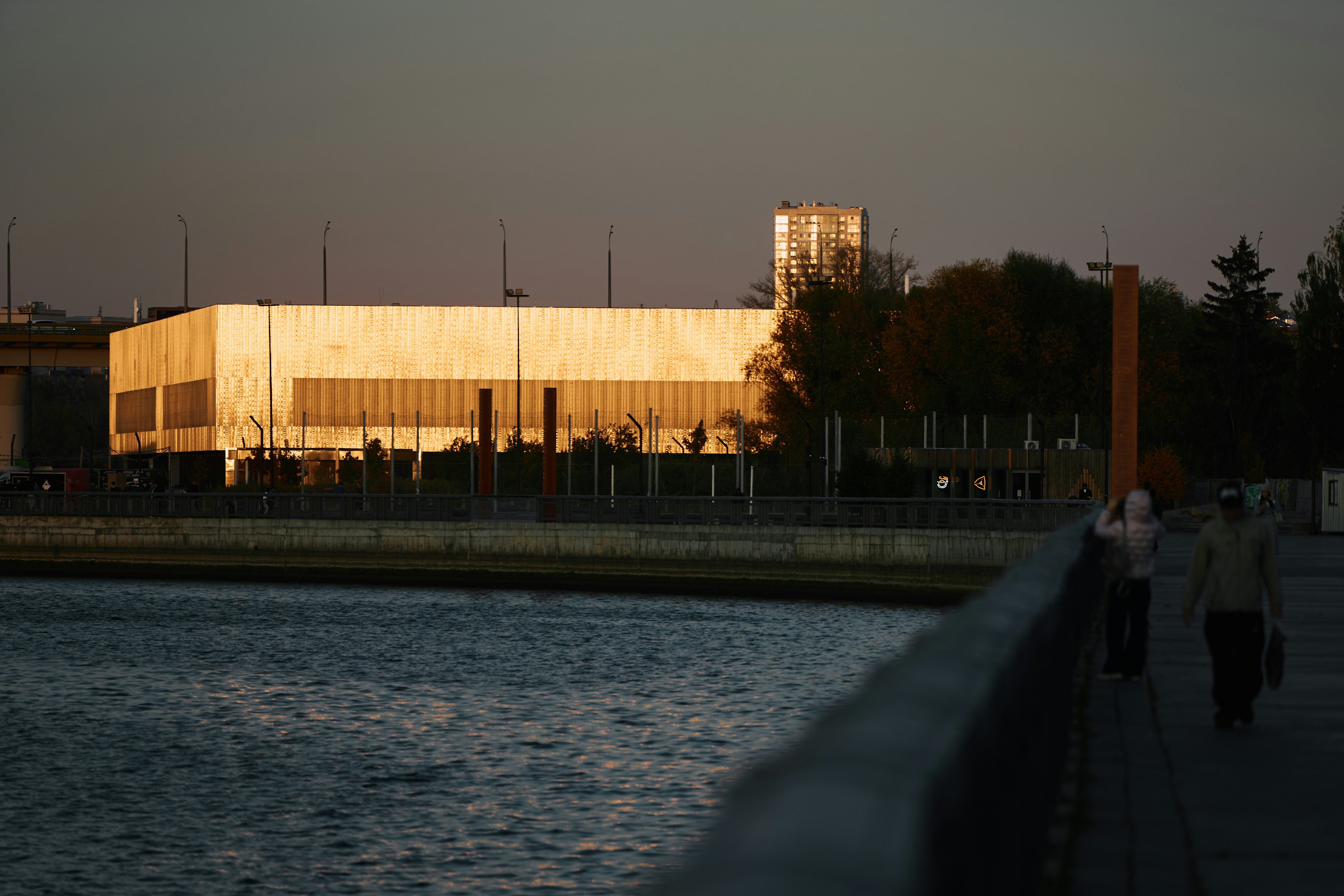 Modern building illuminated by golden sunset light.